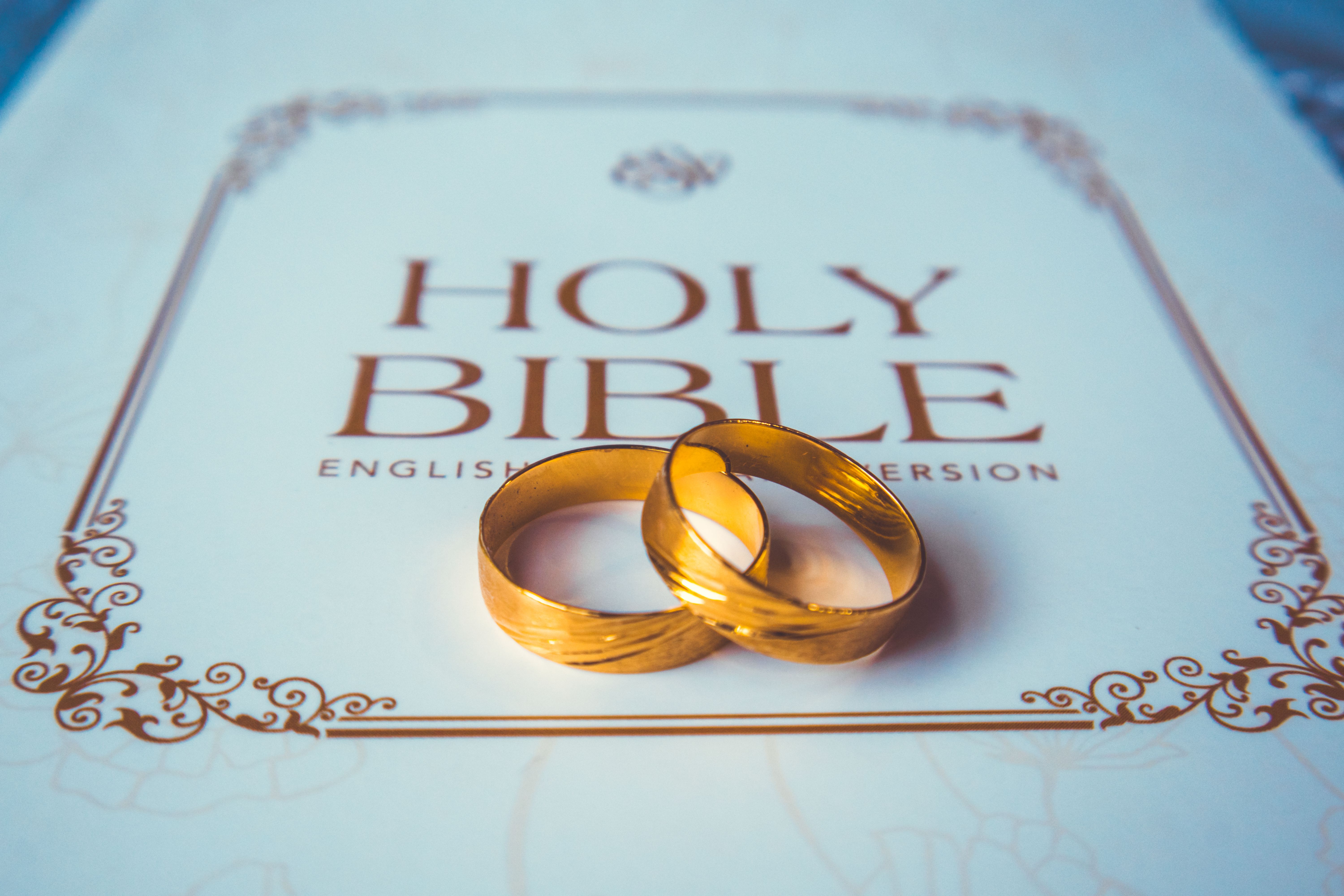 Golden Wedding Rings on Holy Bible Cover · Free Stock Photo