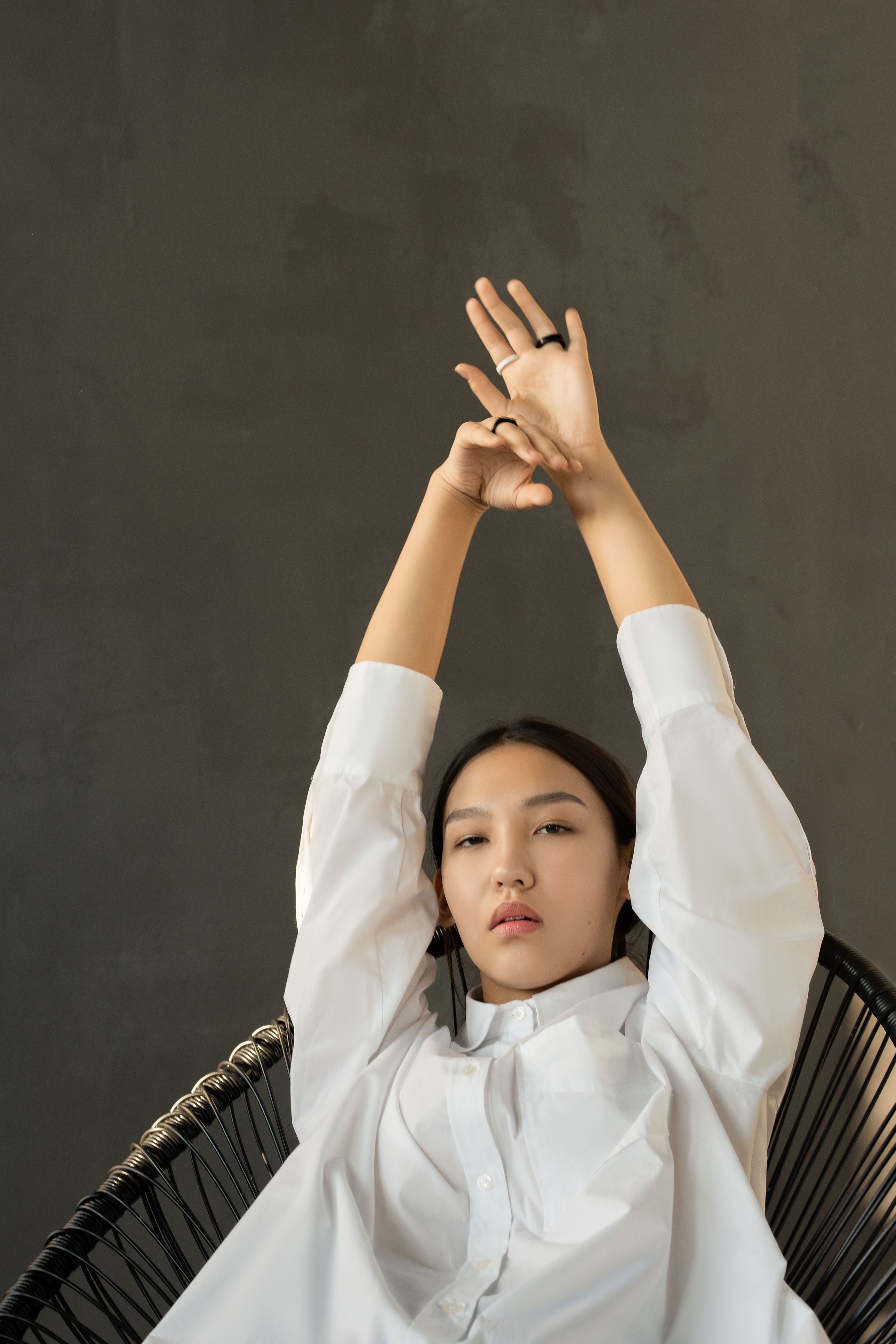 Woman in White Long Sleeve Shirt Raising Her Right Hand · Free Stock Photo
