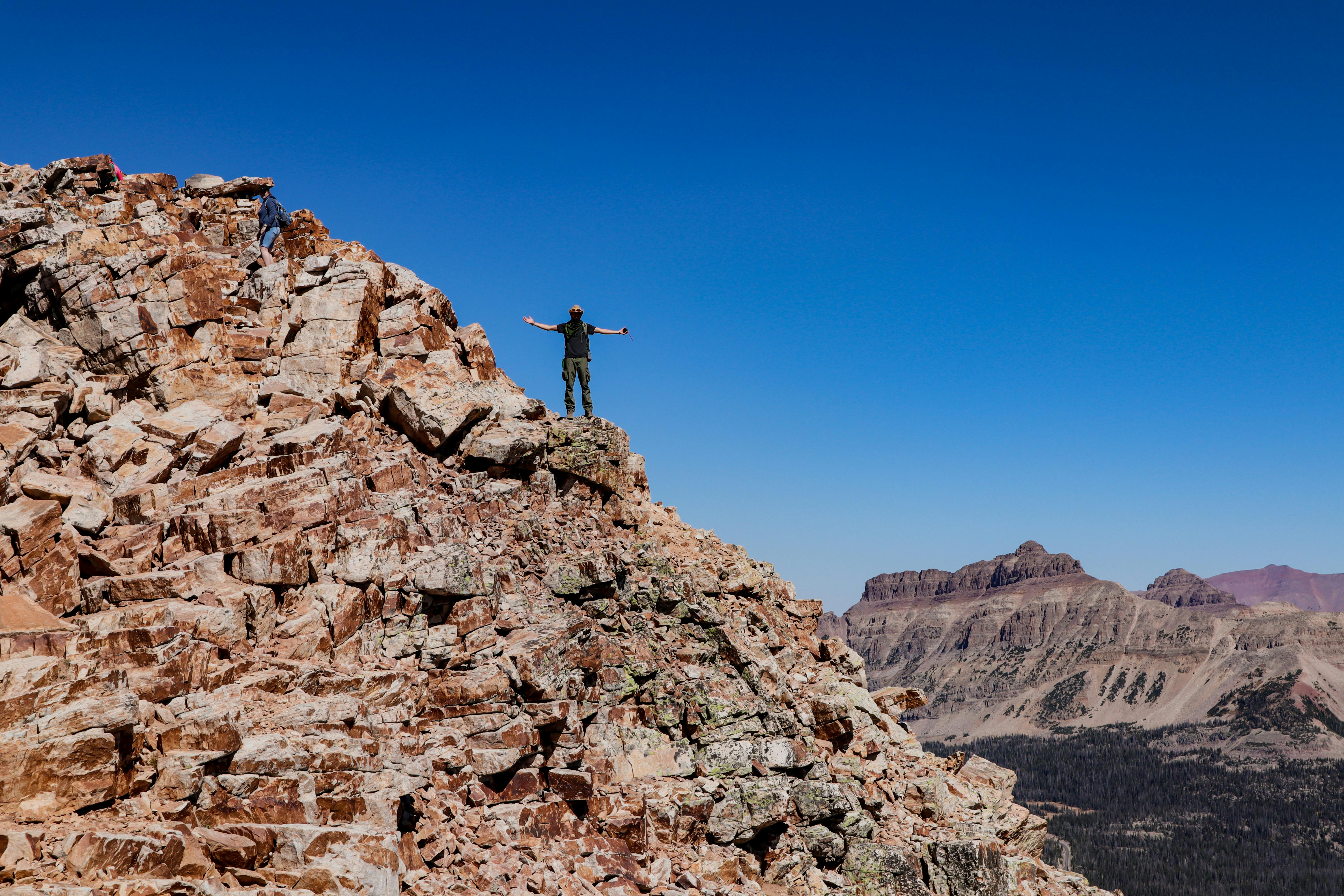 Person Standing on Top of Rock · Free Stock Photo