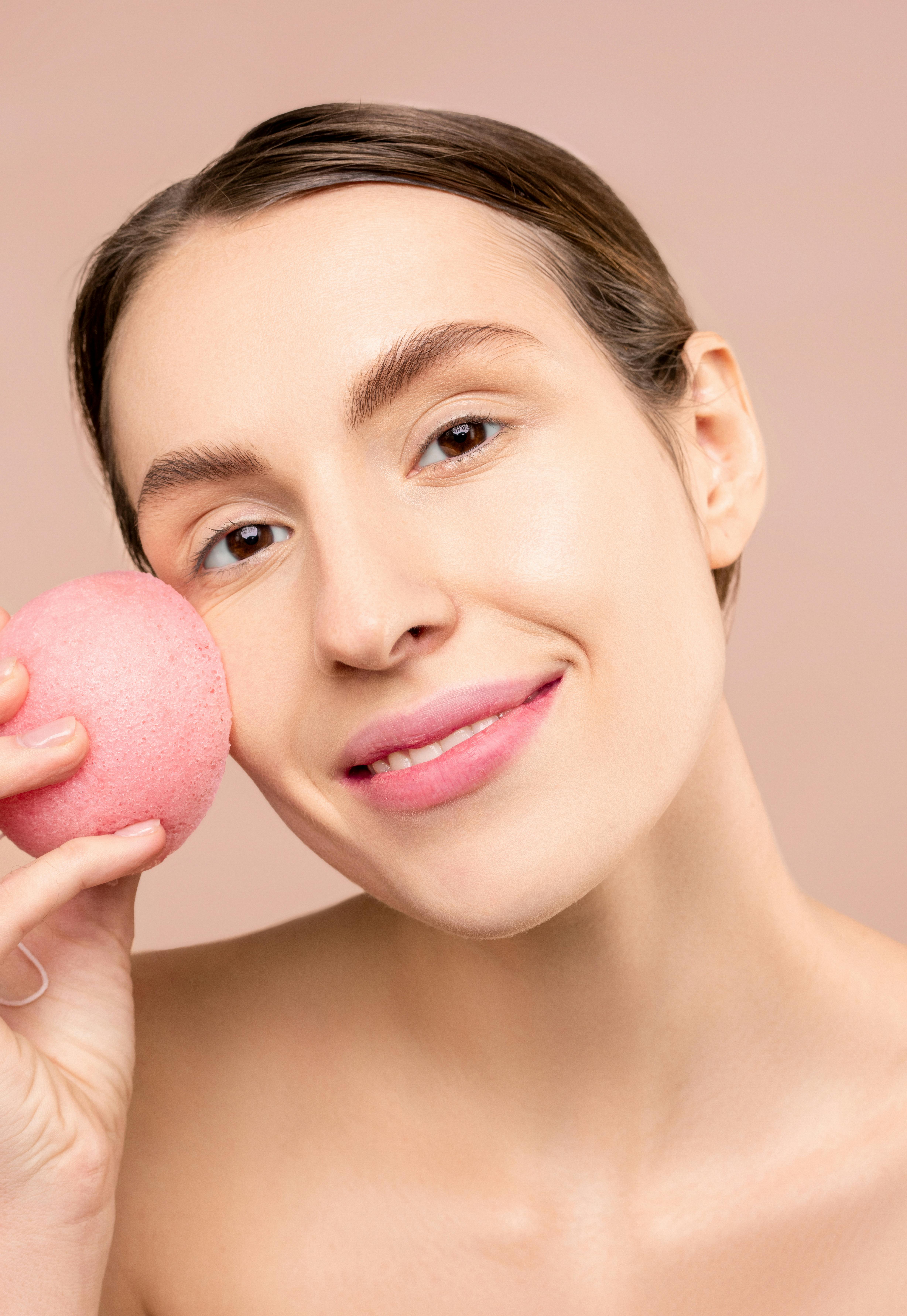 Woman Holding Pink Round Sponge · Free Stock Photo