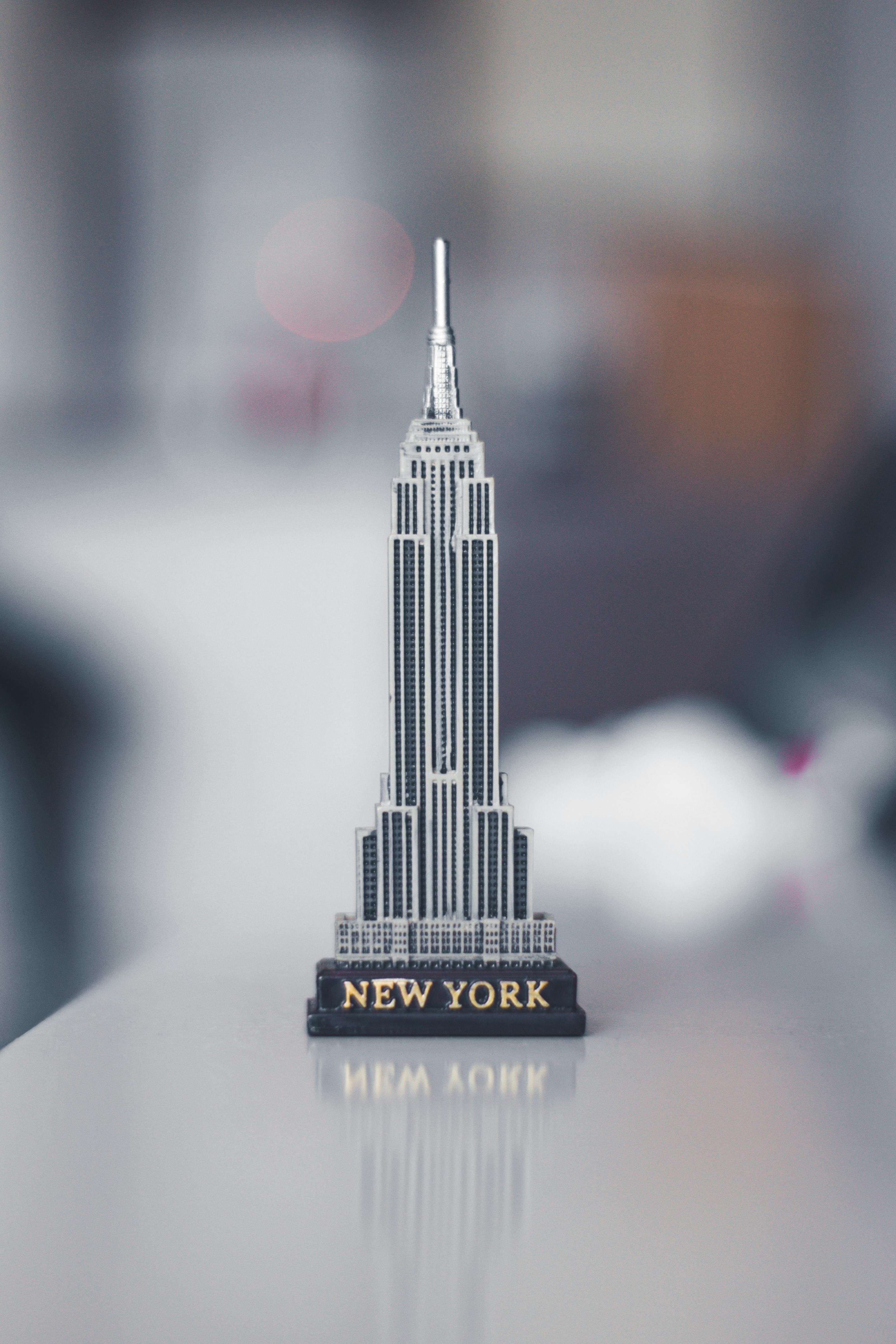 Miniature skyscraper placed on white surface · Free Stock Photo