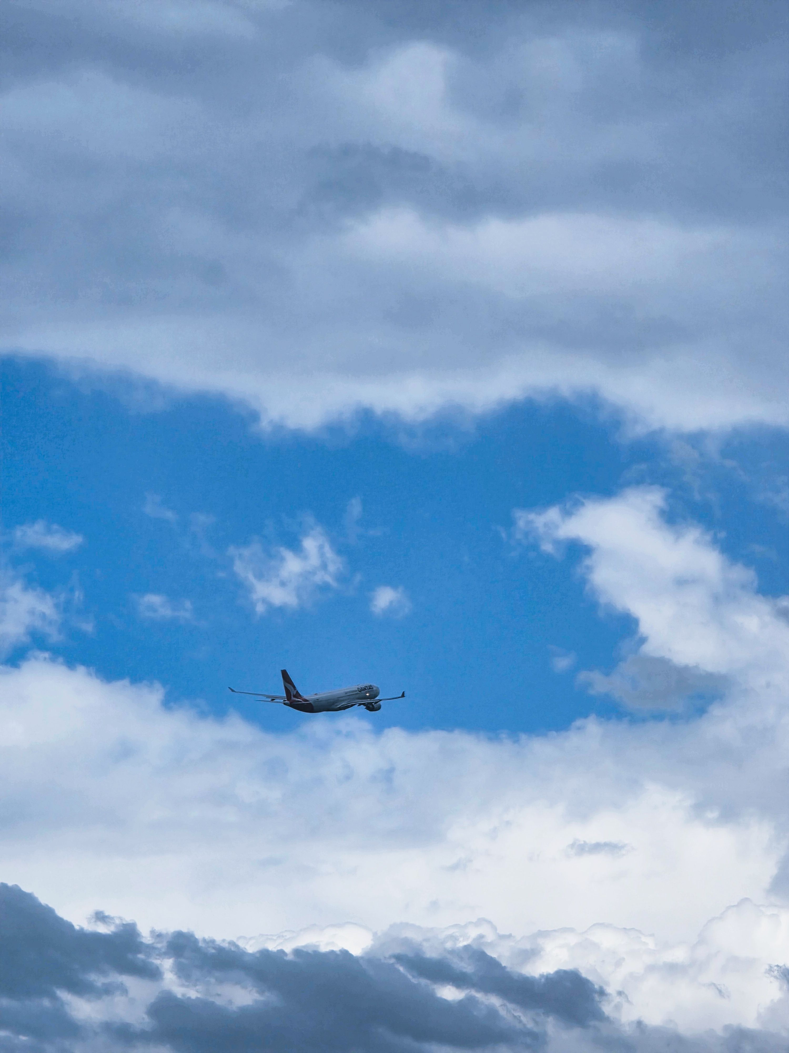 Airplane in Bright Blue Sky with Fluffy Clouds · Free Stock Photo