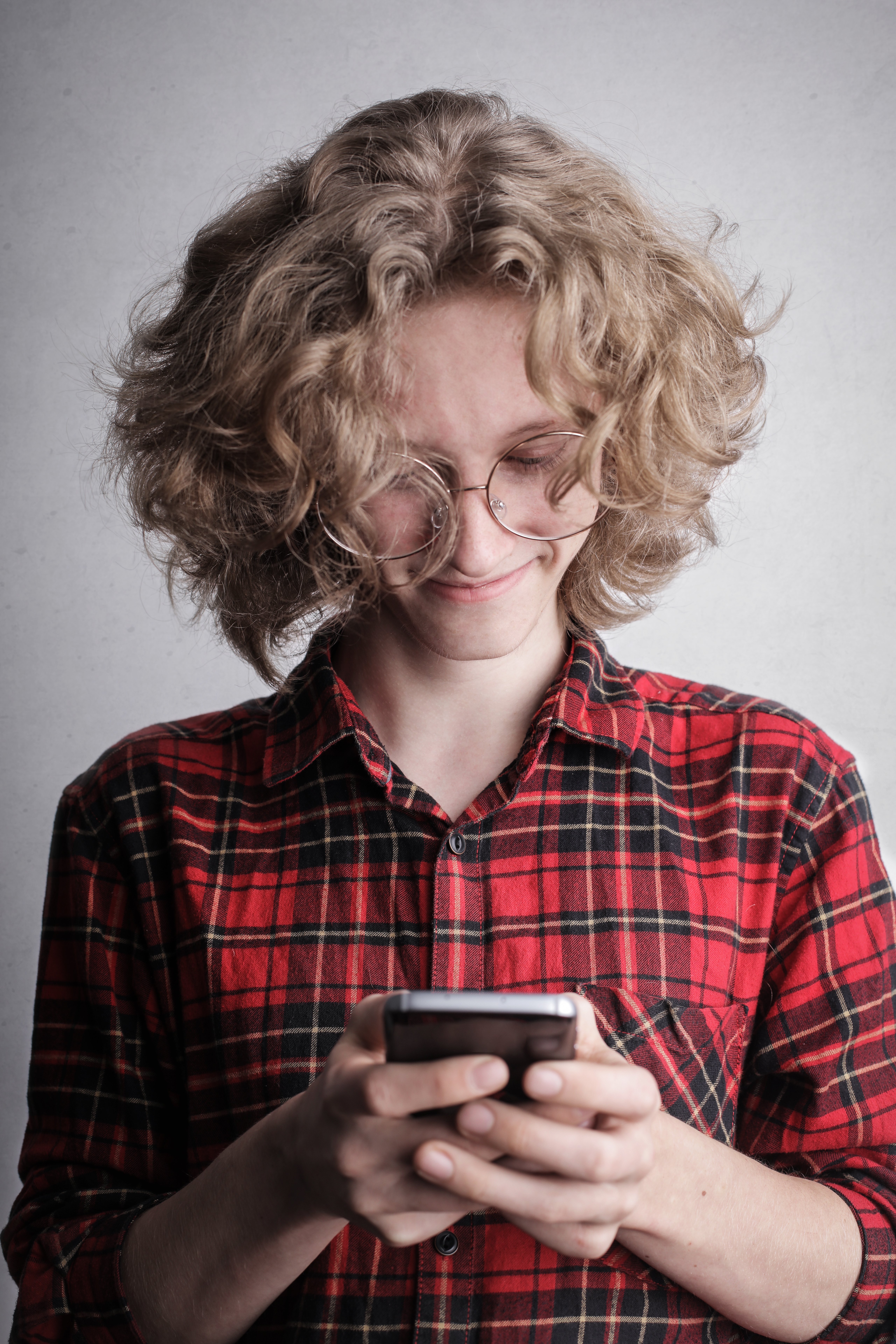 Portrait Photo of Smiling Person in Red and Black Plaid Shirt Texting ...