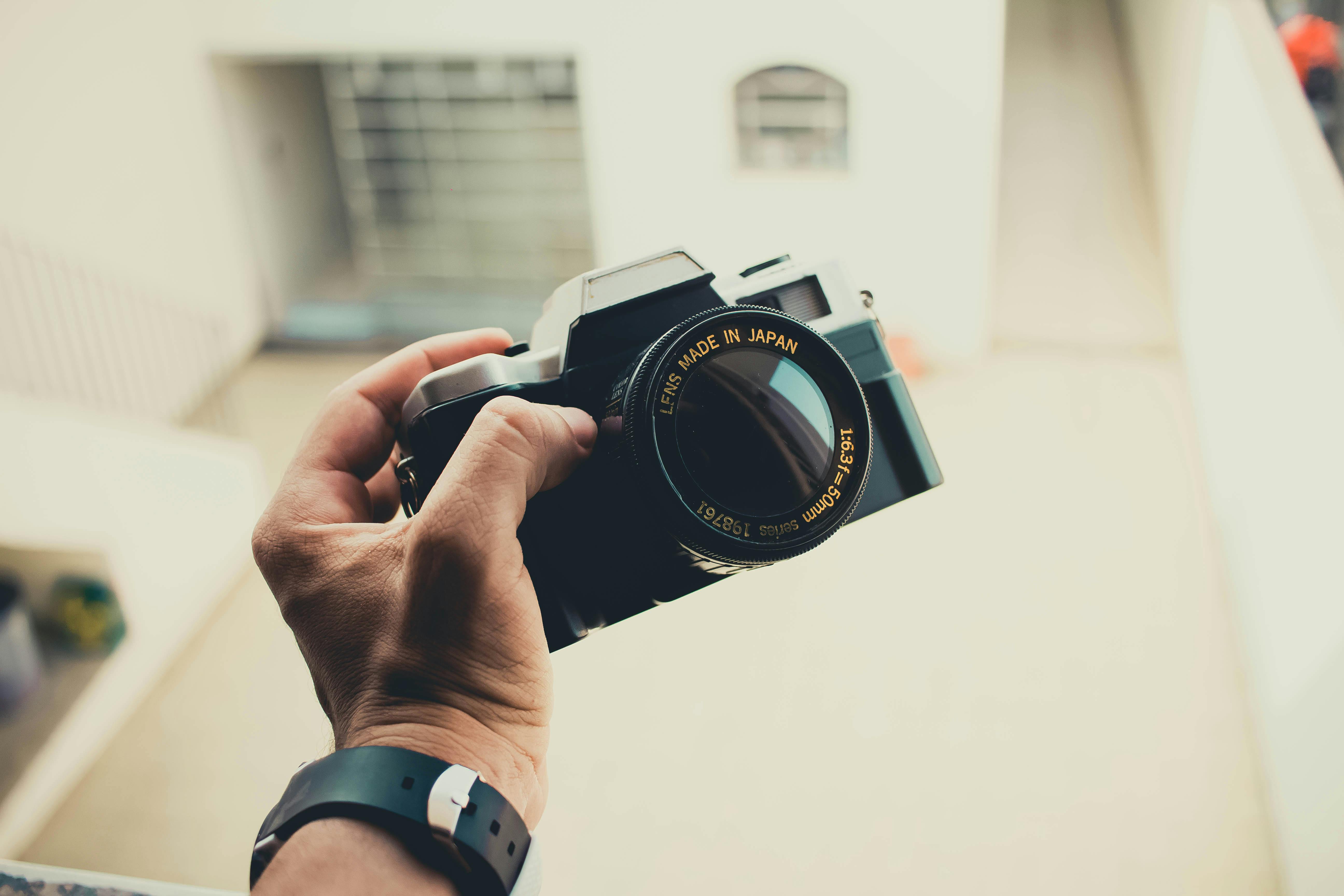 Crop photographer with photo camera in patio · Free Stock Photo