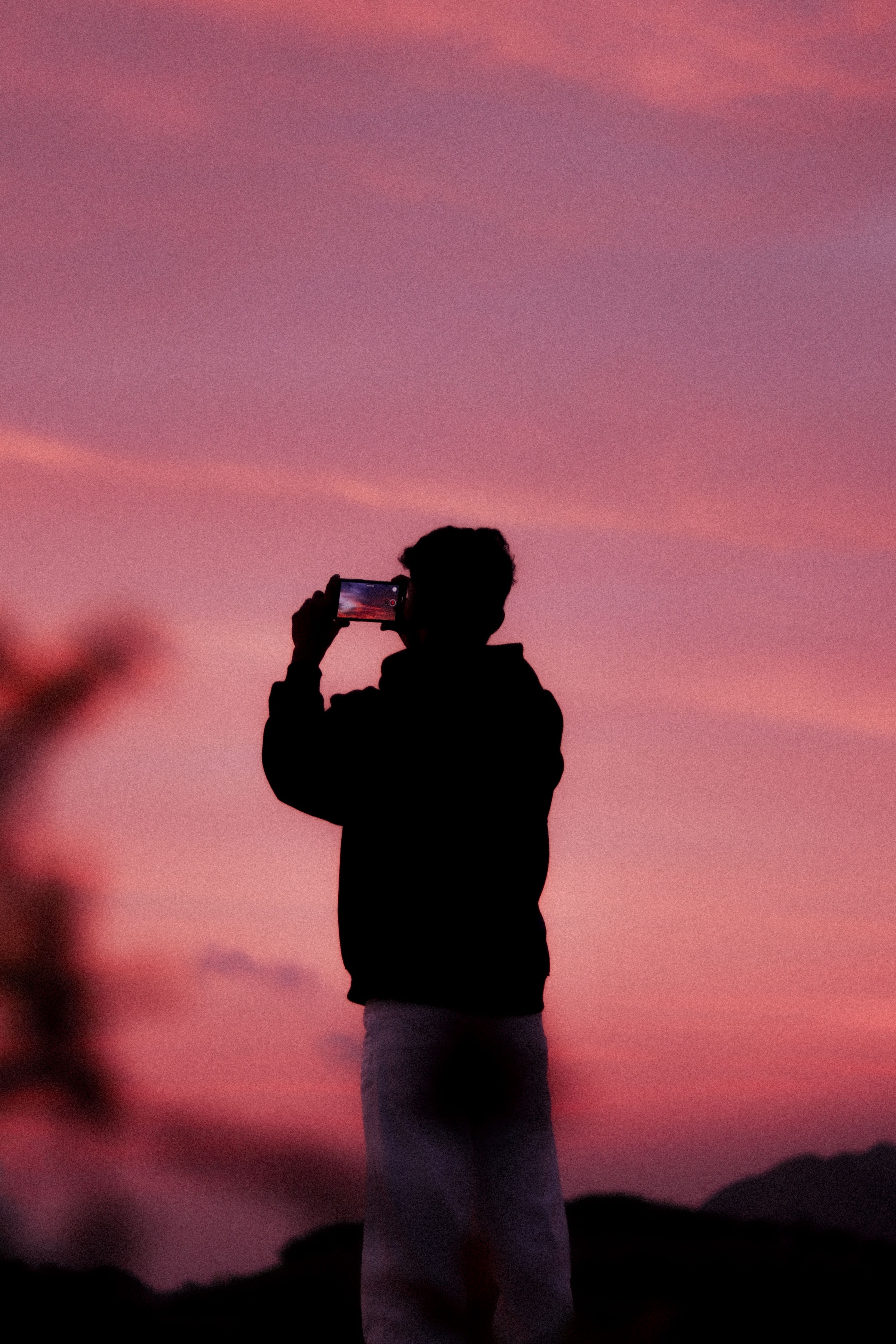 Silhouette of Person Photographing Sunset Sky · Free Stock Photo