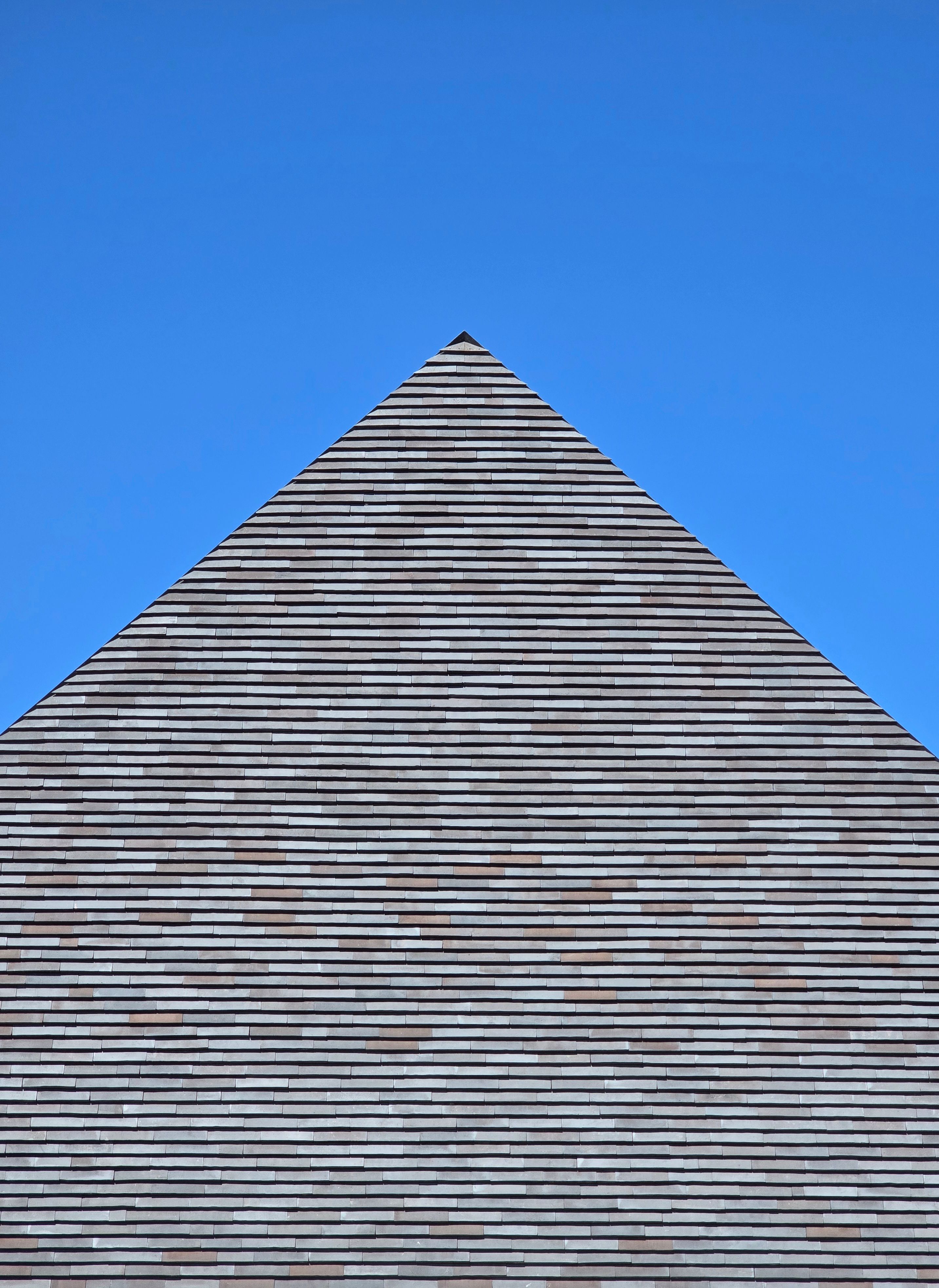 Minimalist Architectural Roof Against Blue Sky · Free Stock Photo