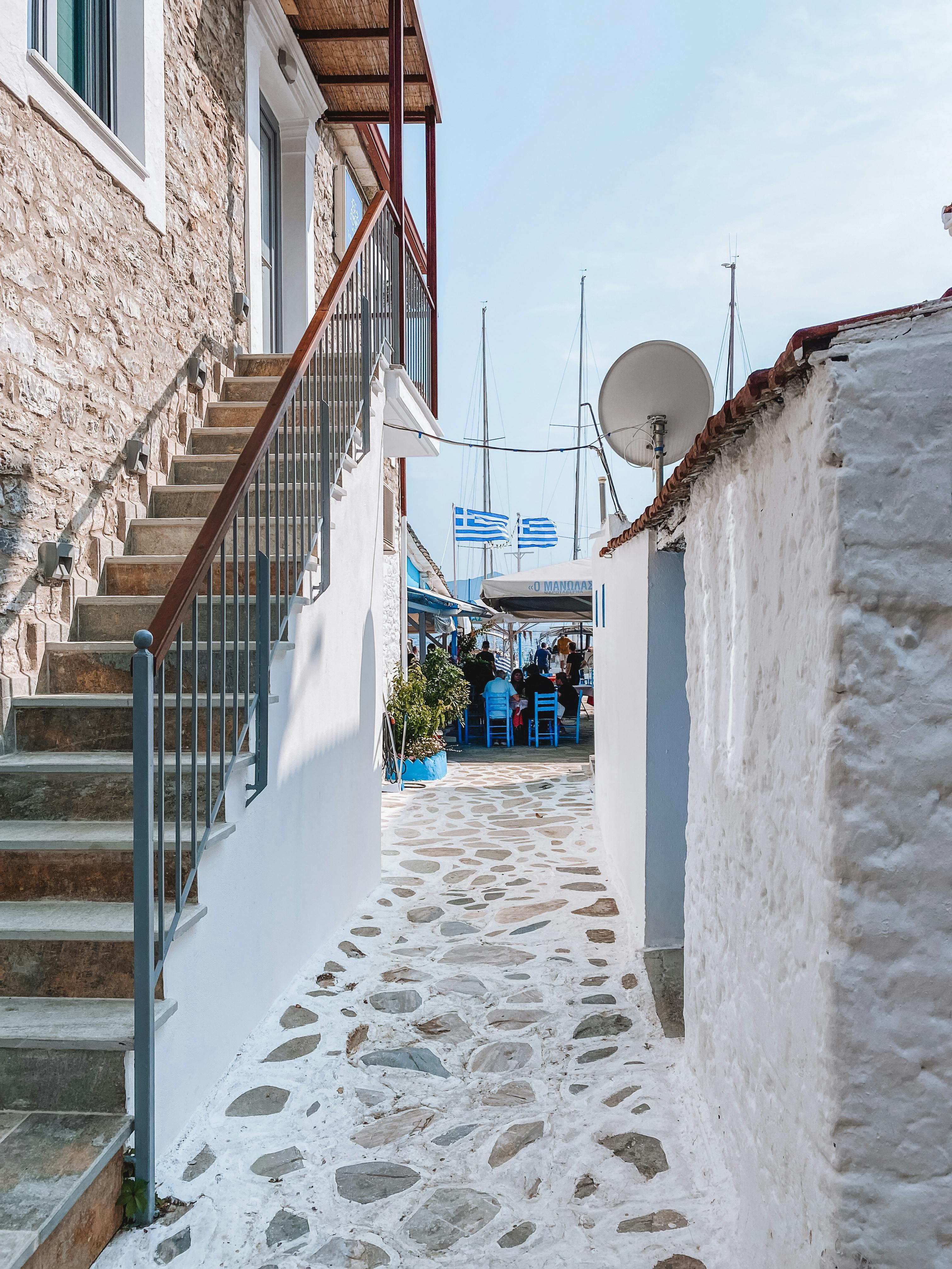 Charming Alleyway in Trikeri Greece with Greek Flags · Free Stock Photo