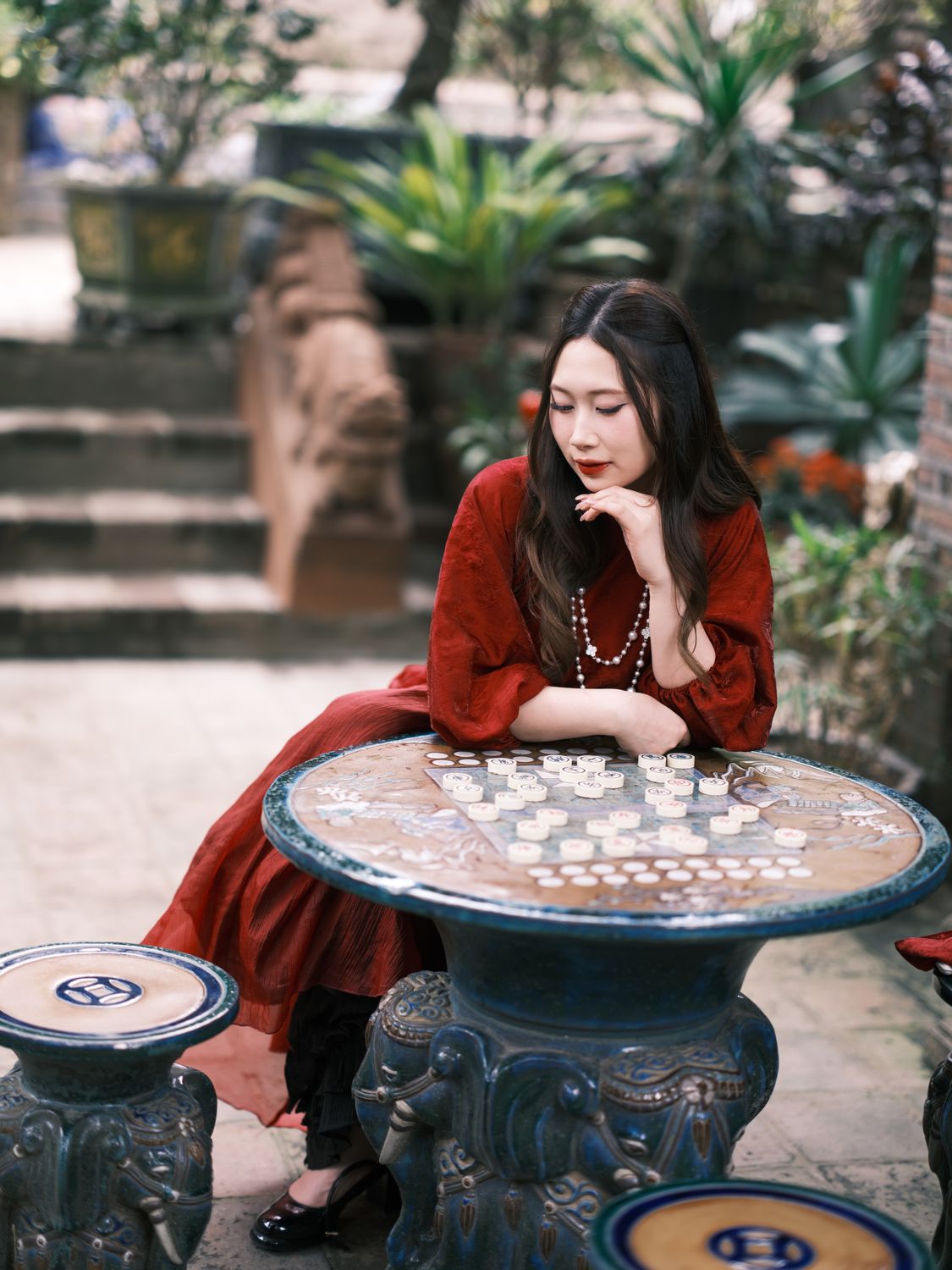 Young Woman Engaged in Traditional Chinese Chess Game · Free Stock Photo