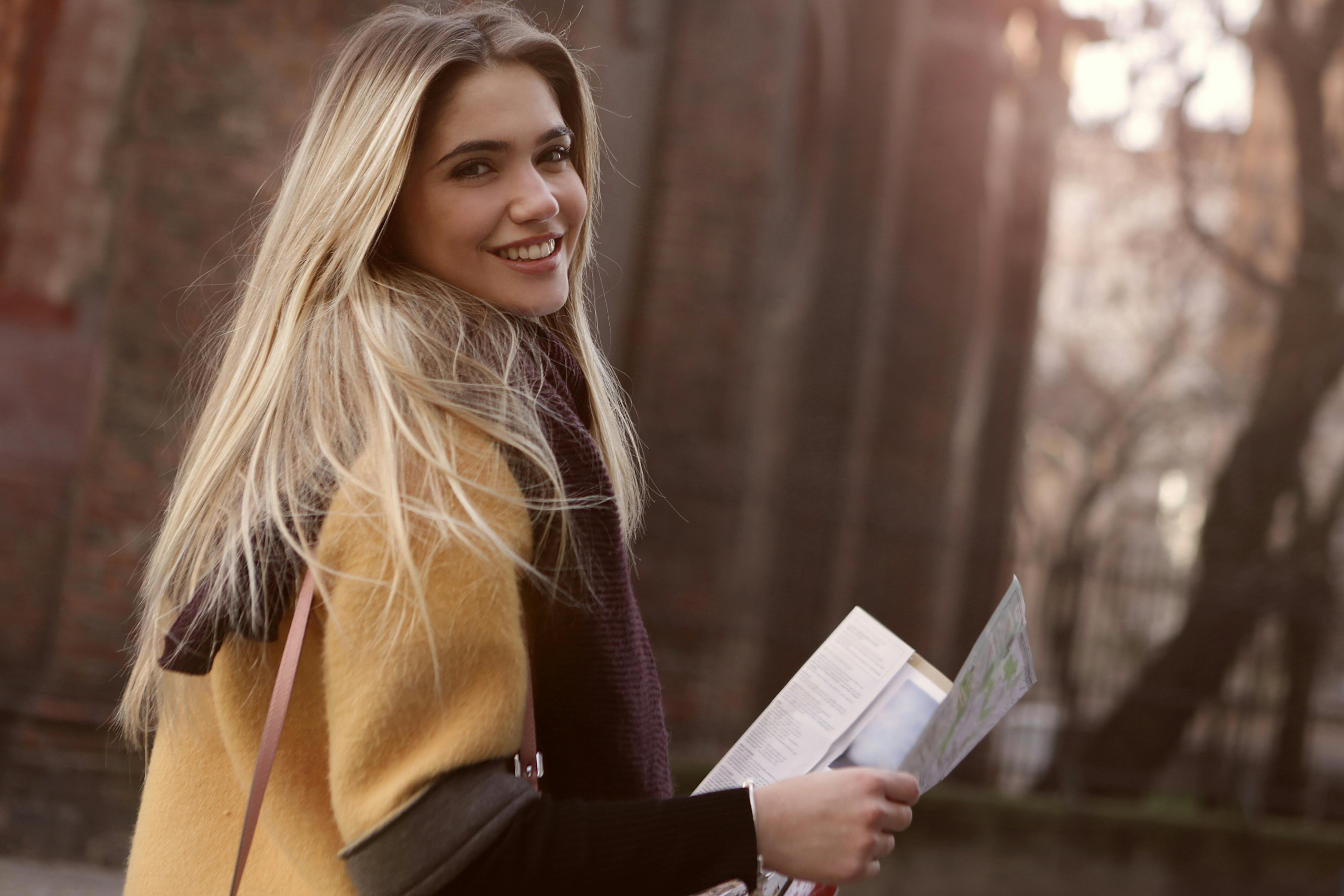 Woman Smiling While Holding Paper · Free Stock Photo Woman Smiling While Holding Paper · Free Stock Photo