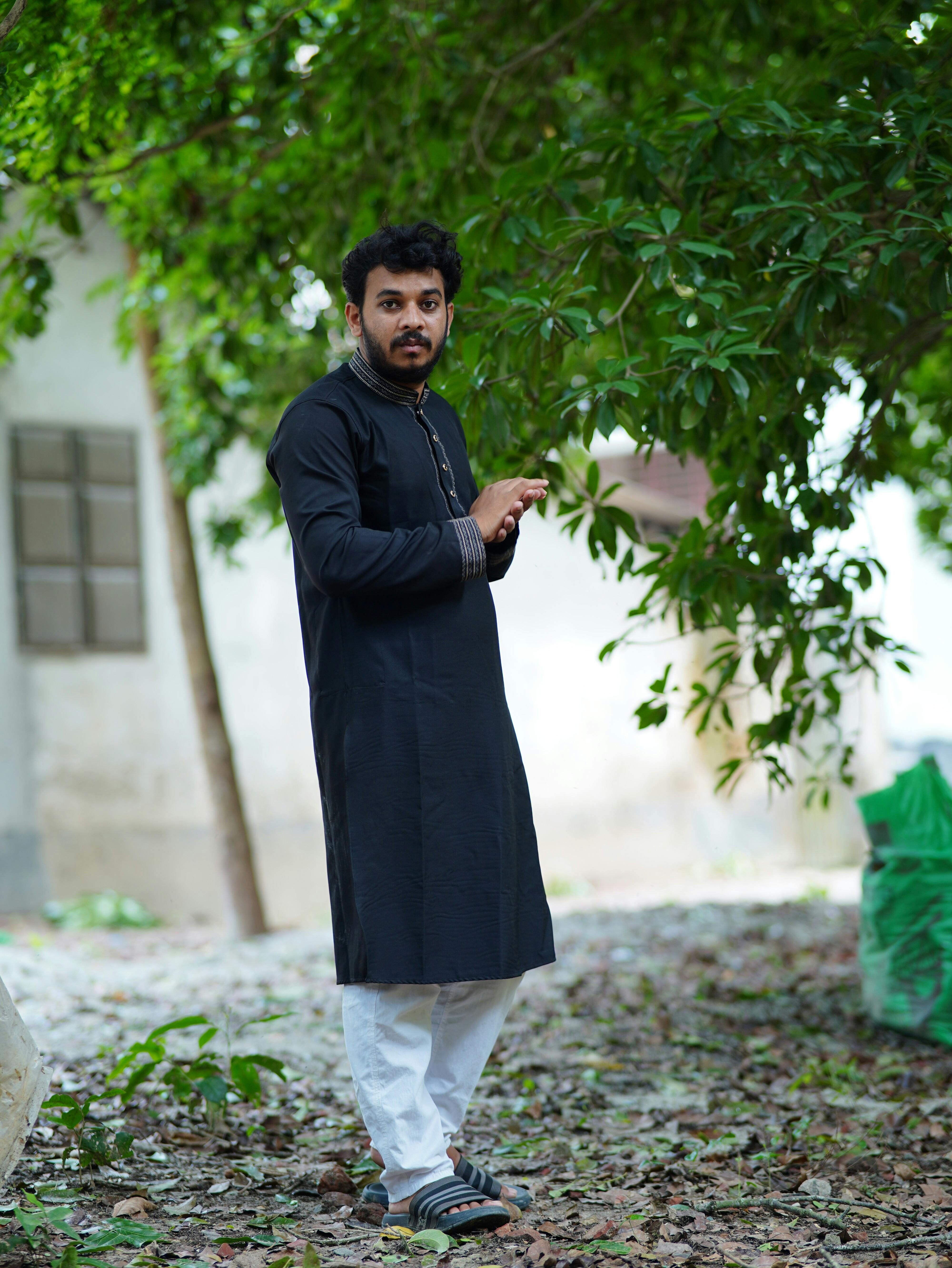 Young Man in Traditional Attire Outdoors · Free Stock Photo
