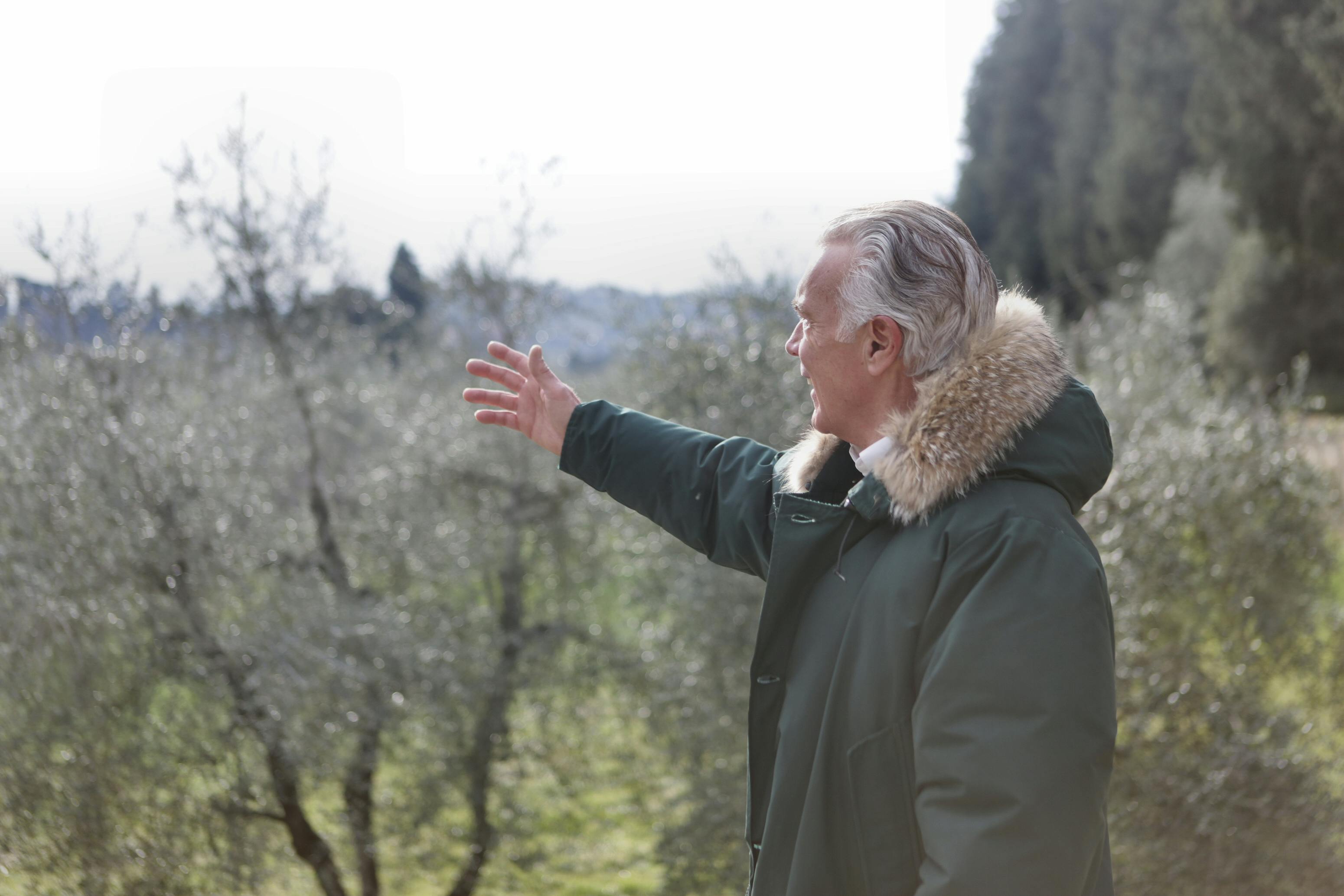 Man in Gray Jacket Raising His Hand · Free Stock Photo