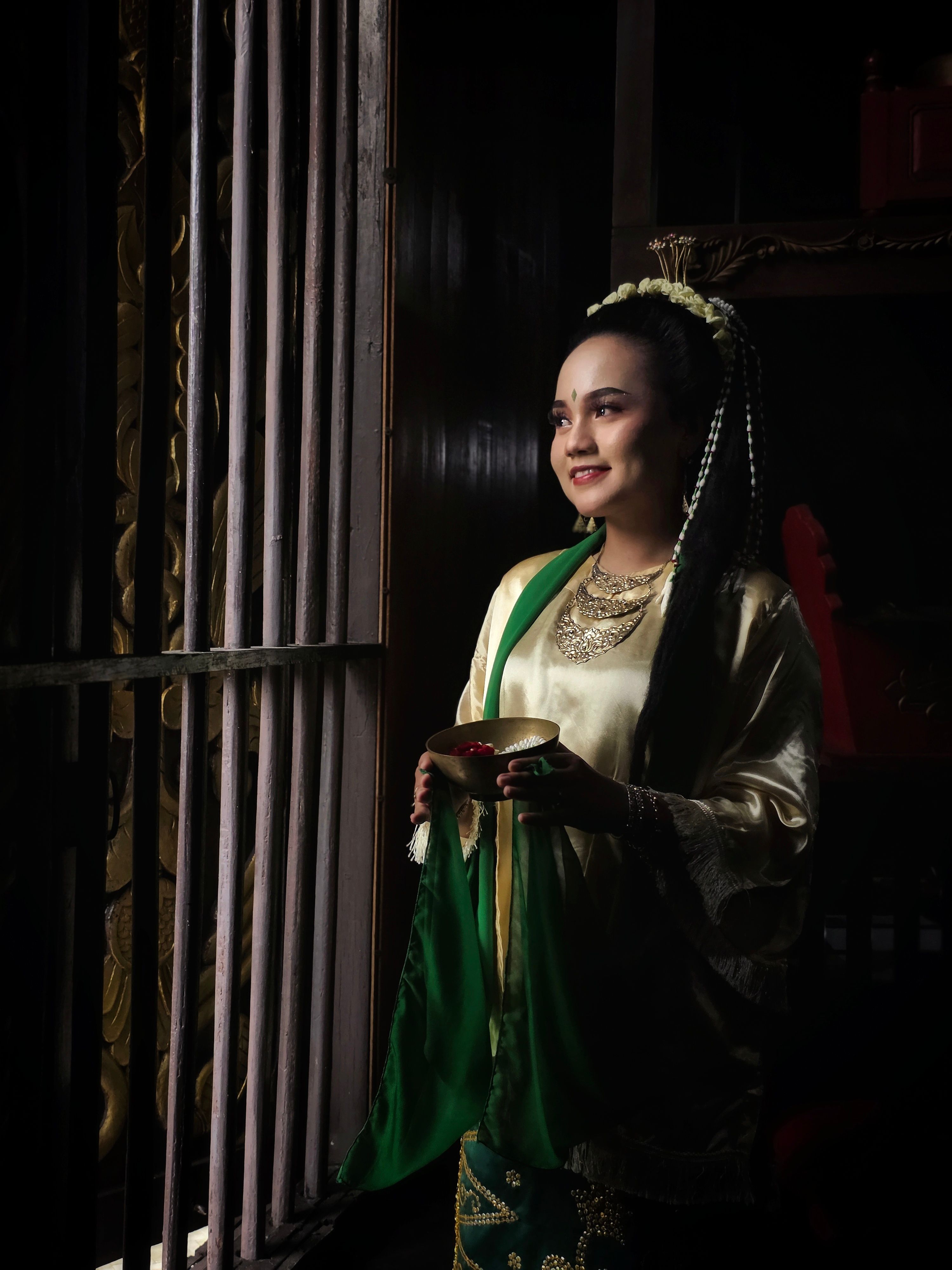 Woman in Traditional Attire Holding a Bowl · Free Stock Photo