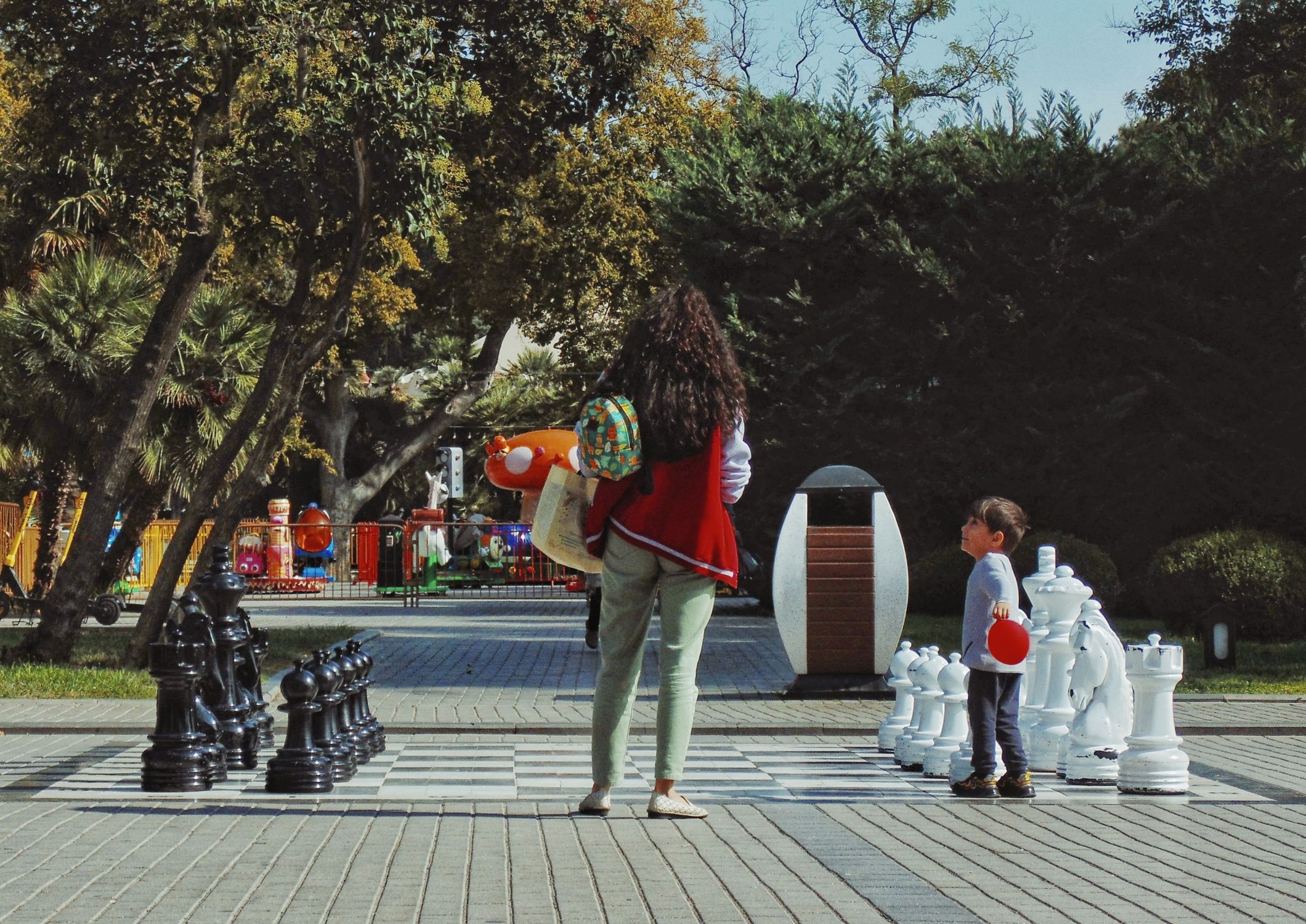 Mother and Child at Outdoor Chess Game · Free Stock Photo