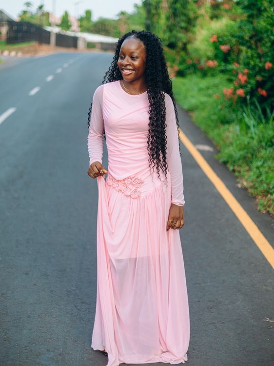 Elegant Woman in Pink Dress on a Nigerian Road · Free Stock Photo