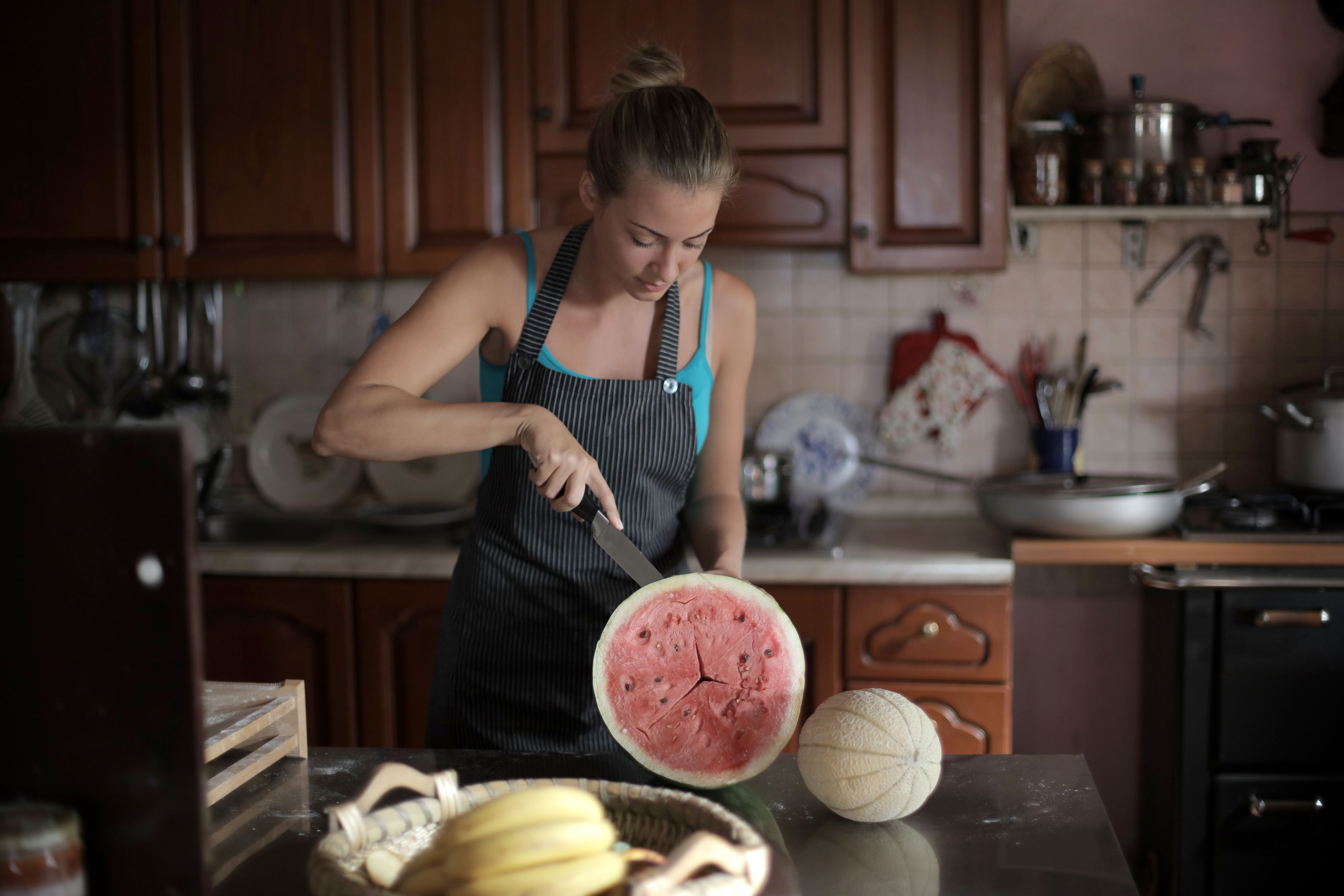 Woman Slicing Watermelon Free Stock Photo woman-slicing-watermelon-free-stock-photo