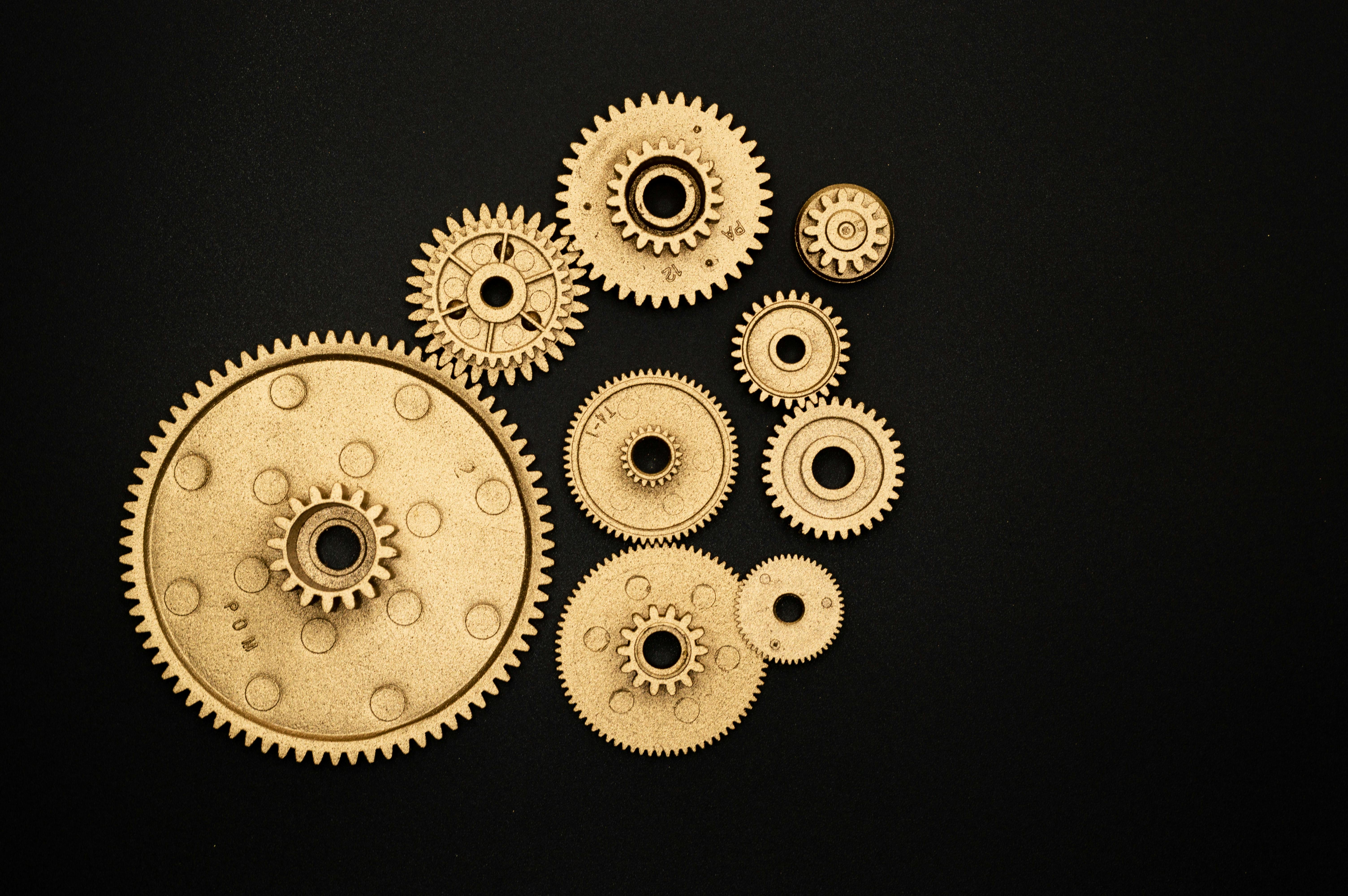 Photo of Golden Cogwheel on Black Background · Free Stock Photo