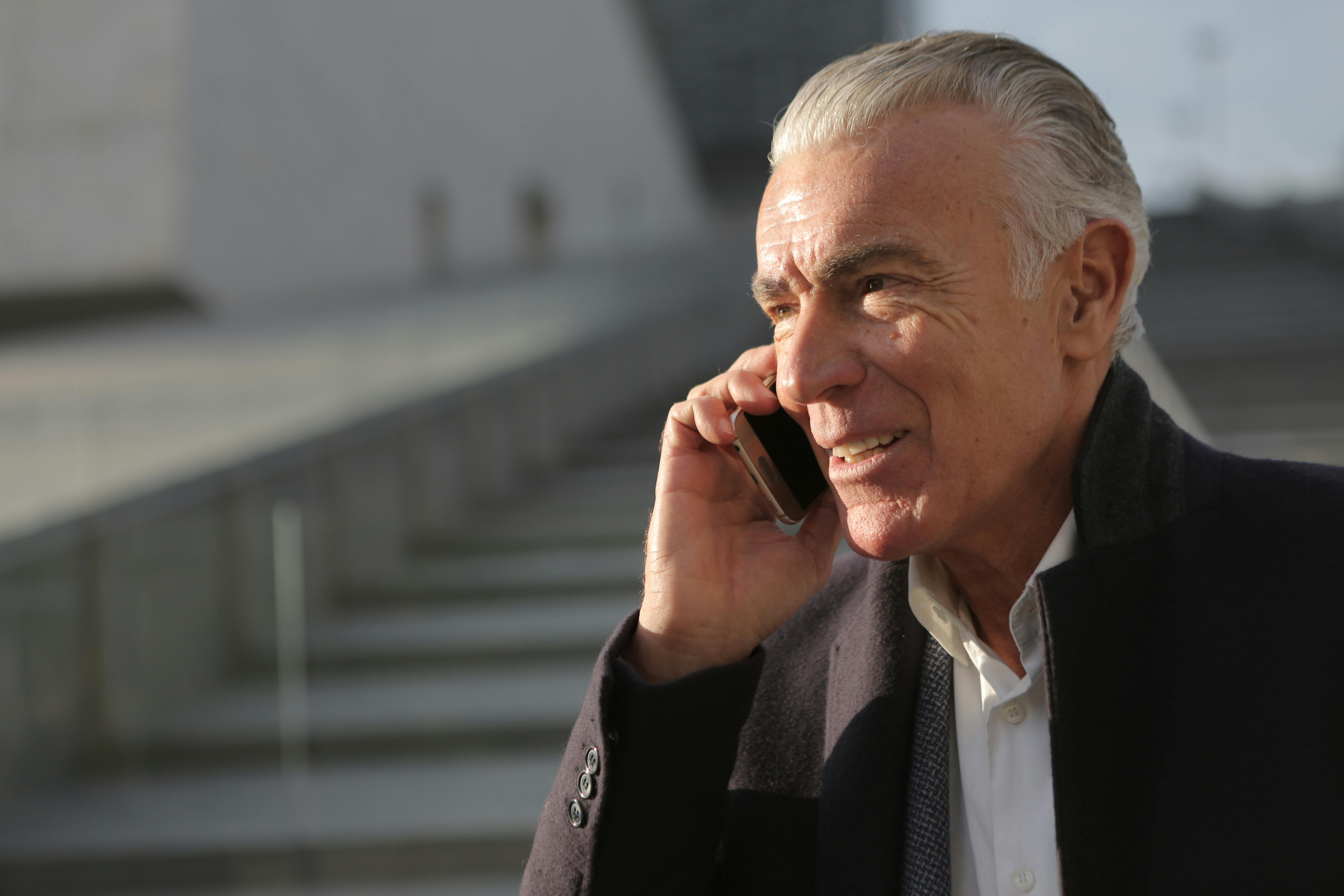 Man in Black Suit Jacket Talking on Phone · Free Stock Photo