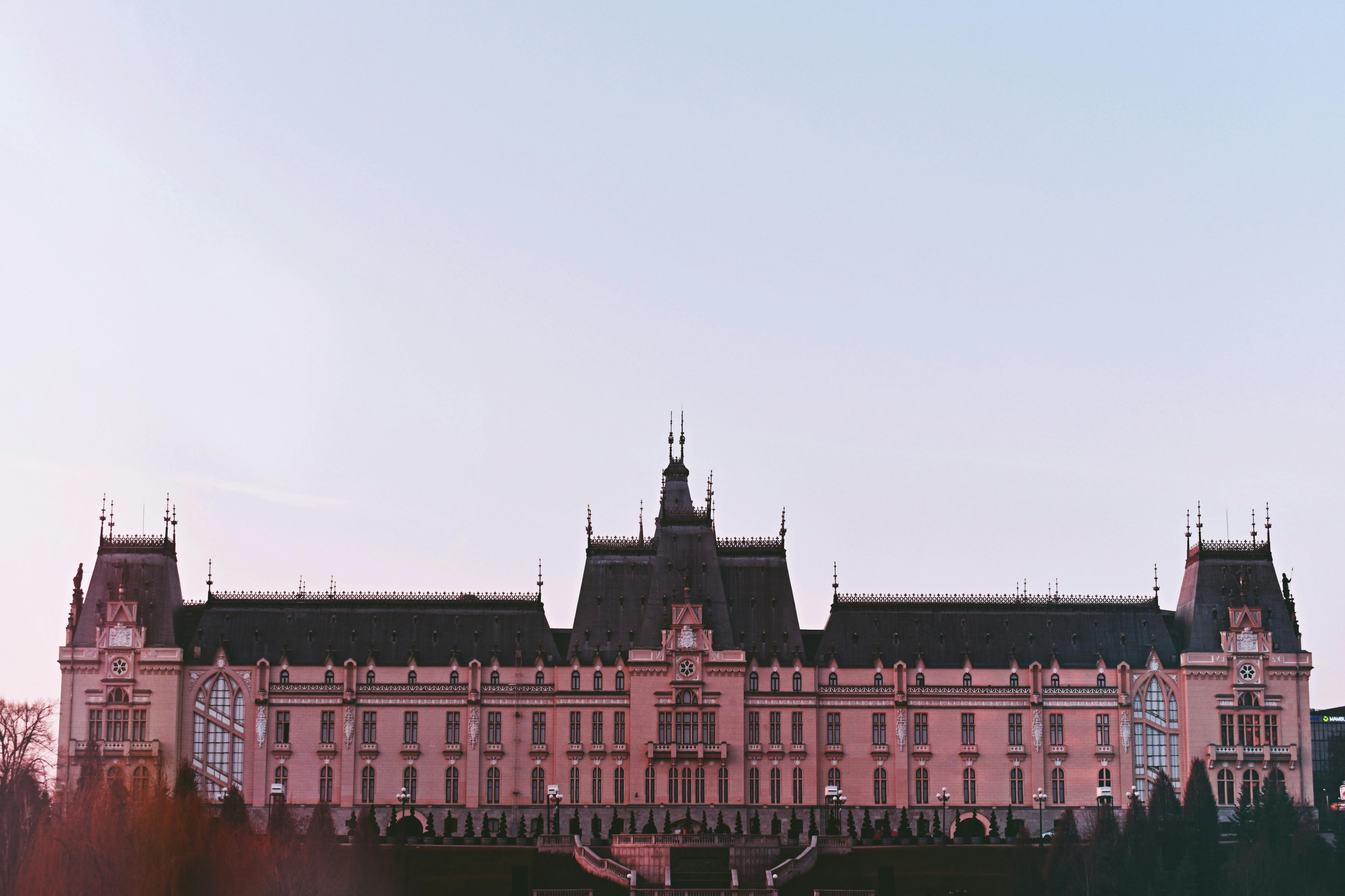 Facade of old palace under blue sky · Free Stock Photo