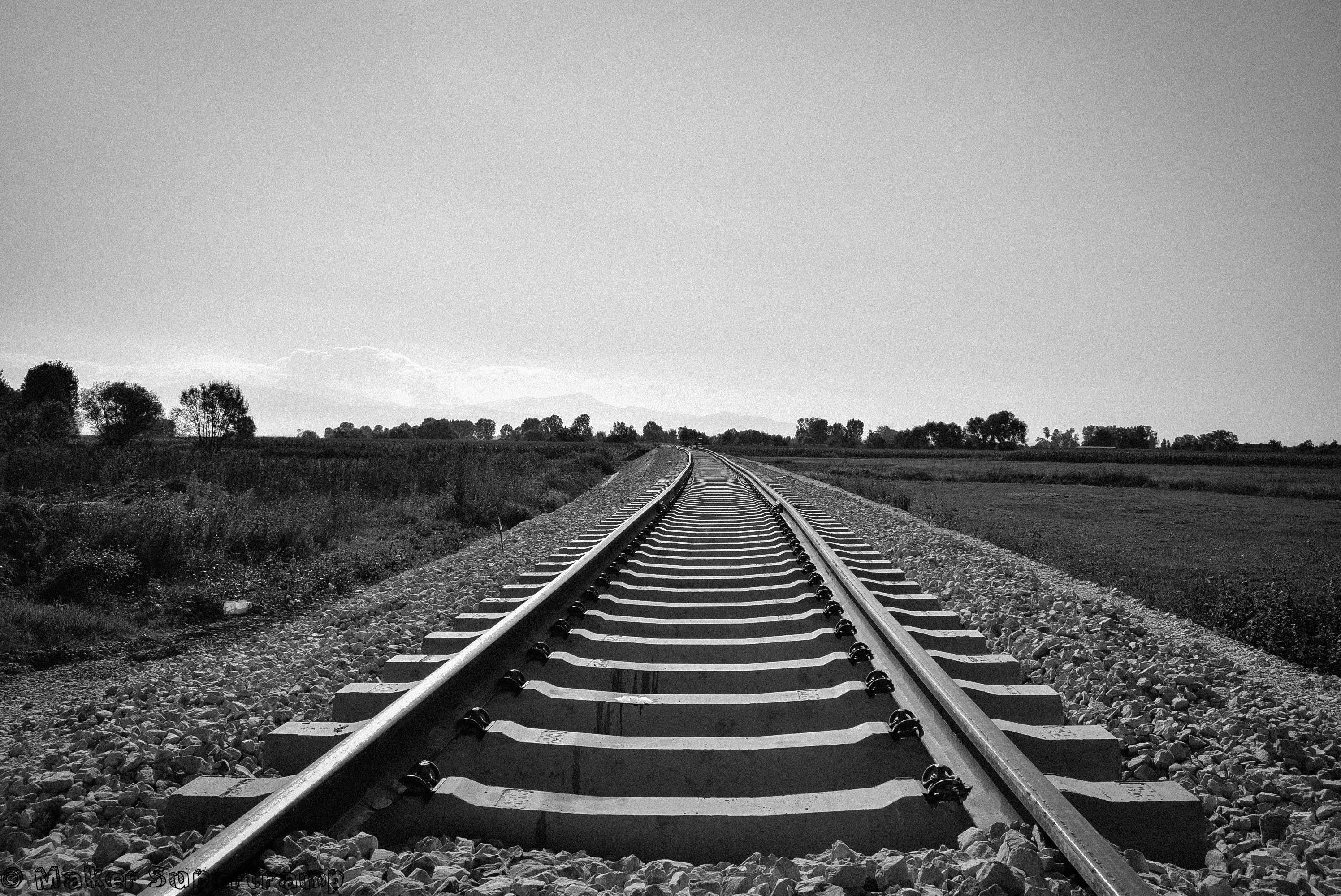 Grayscale Photo of Train Rail · Free Stock Photo