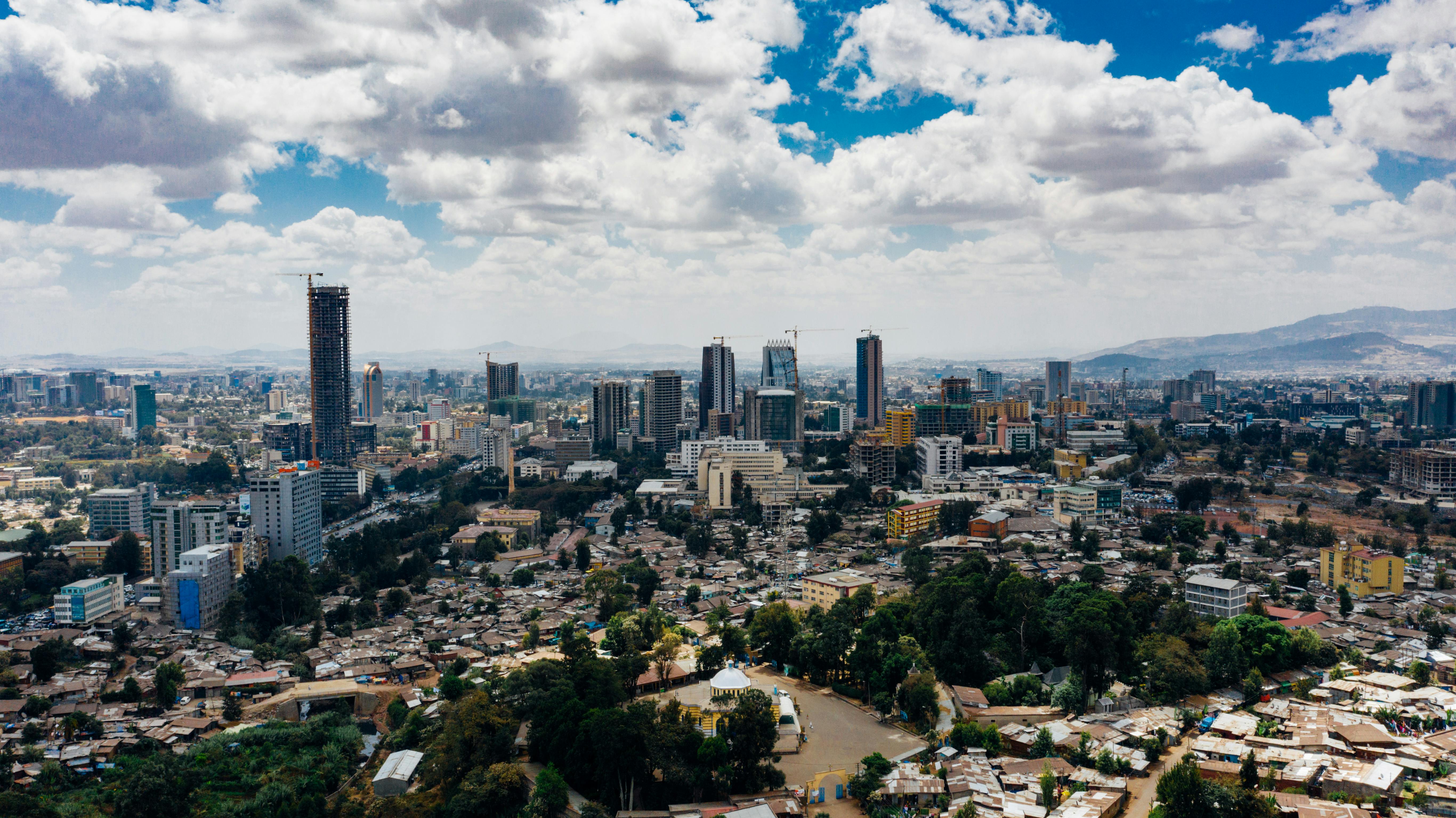 Modern megapolis with skyscrapers under cloudy sky · Free Stock Photo