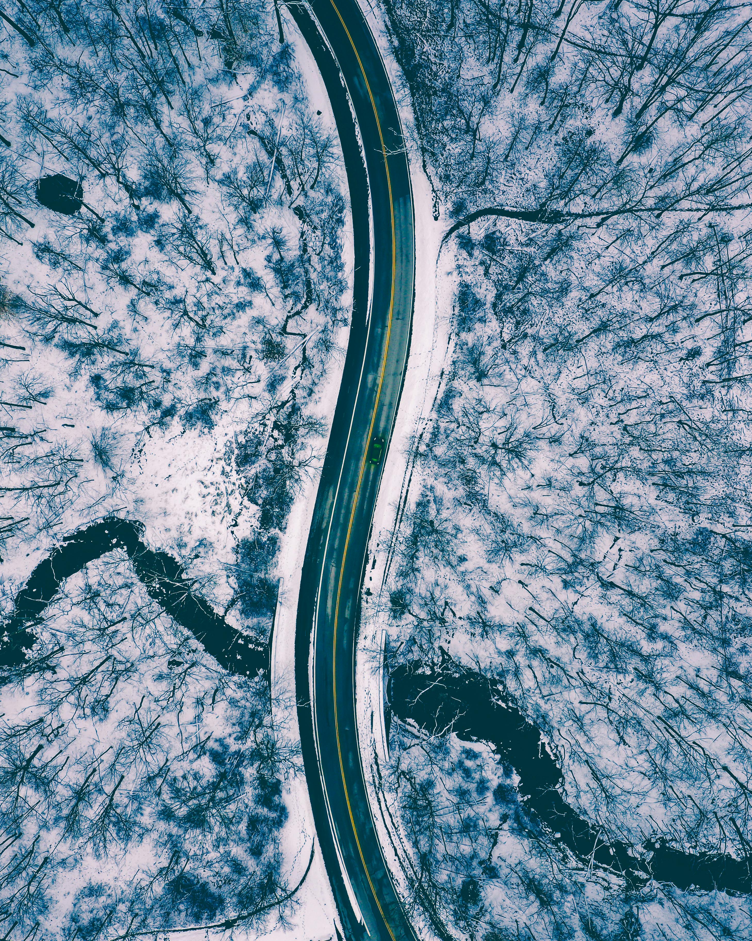 Aerial View of Road in the Middle of Snow Covered Ground · Free Stock Photo
