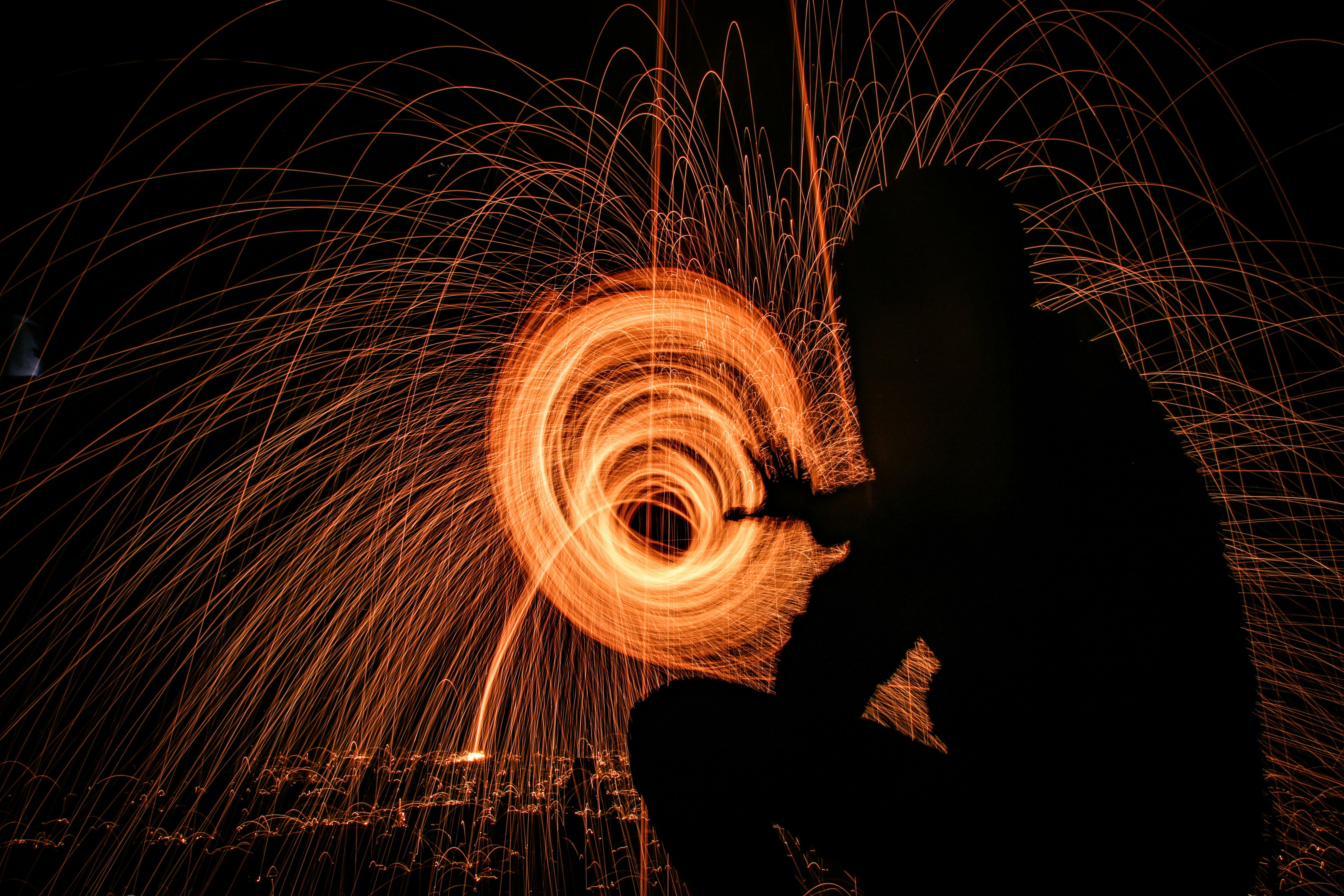 A Person Touching a Spinning Fireball · Free Stock Photo