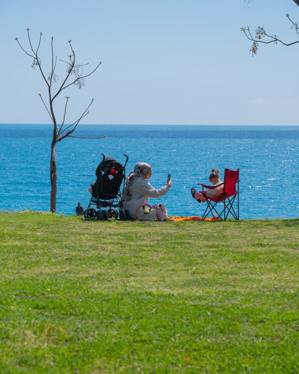 Family Relaxing by the Ocean on a Sunny Day · Free Stock Photo