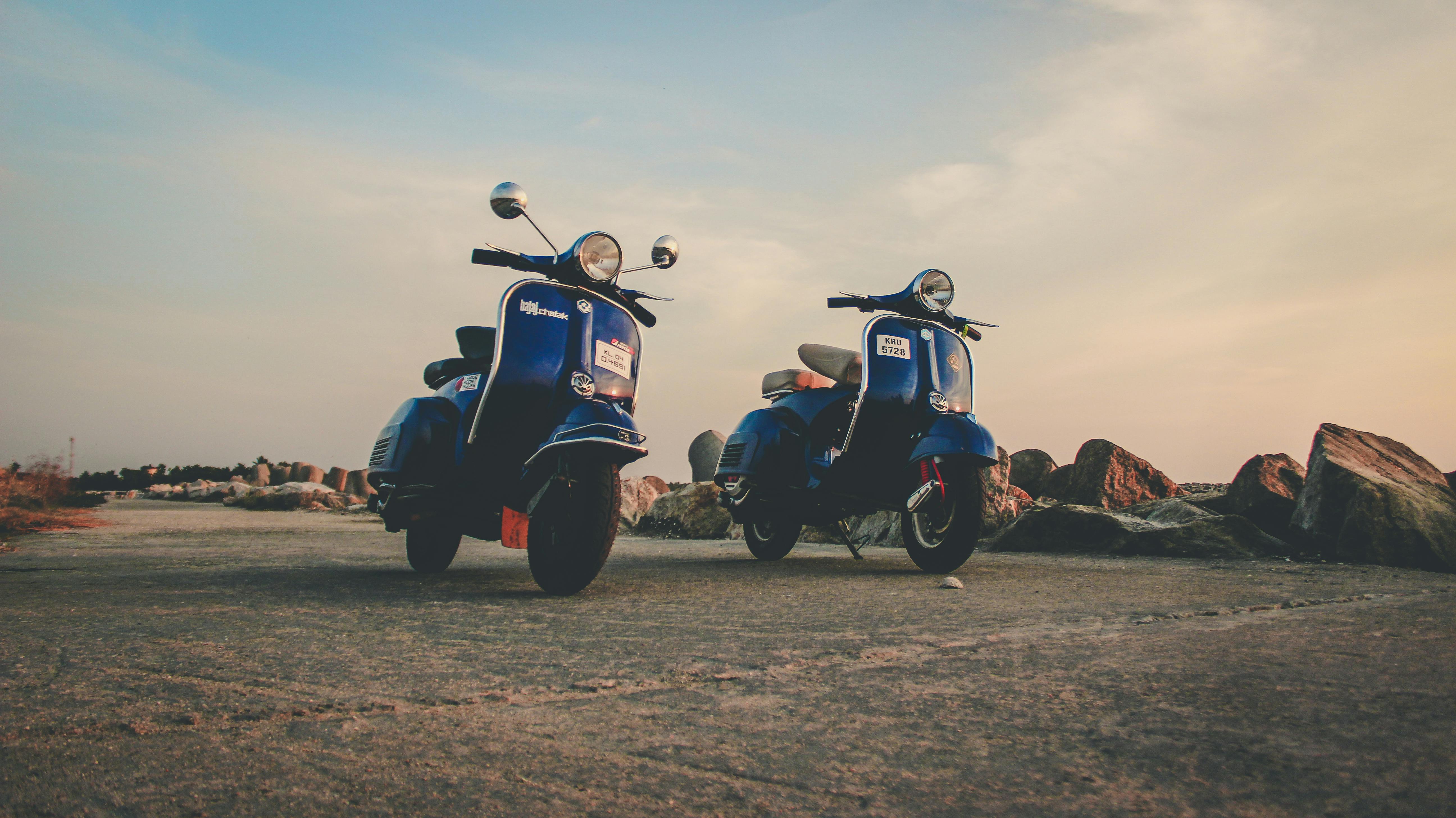 Blue mopeds parked on empty road in countryside · Free Stock Photo