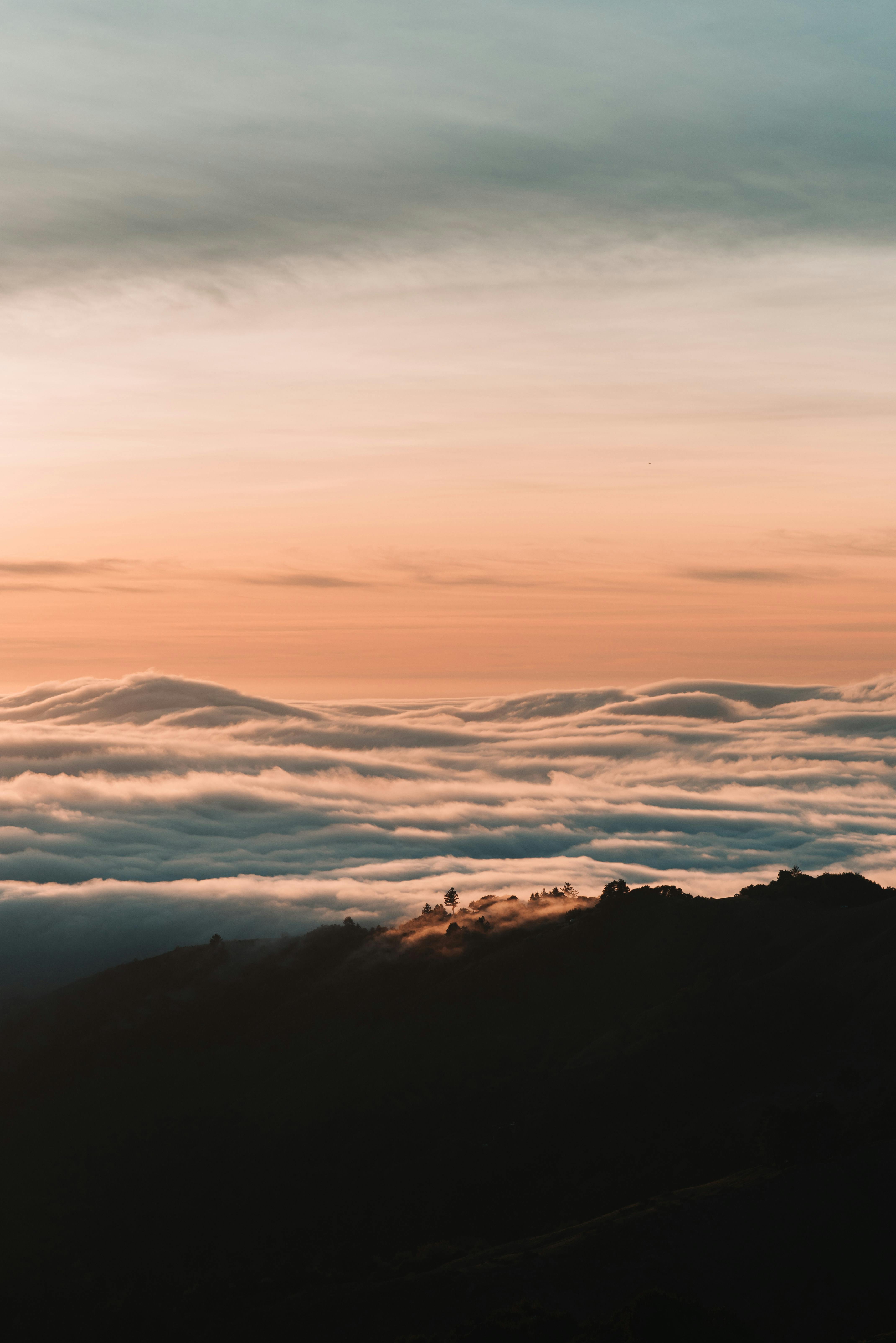Heavy clouds high above mountains in evening · Free Stock Photo