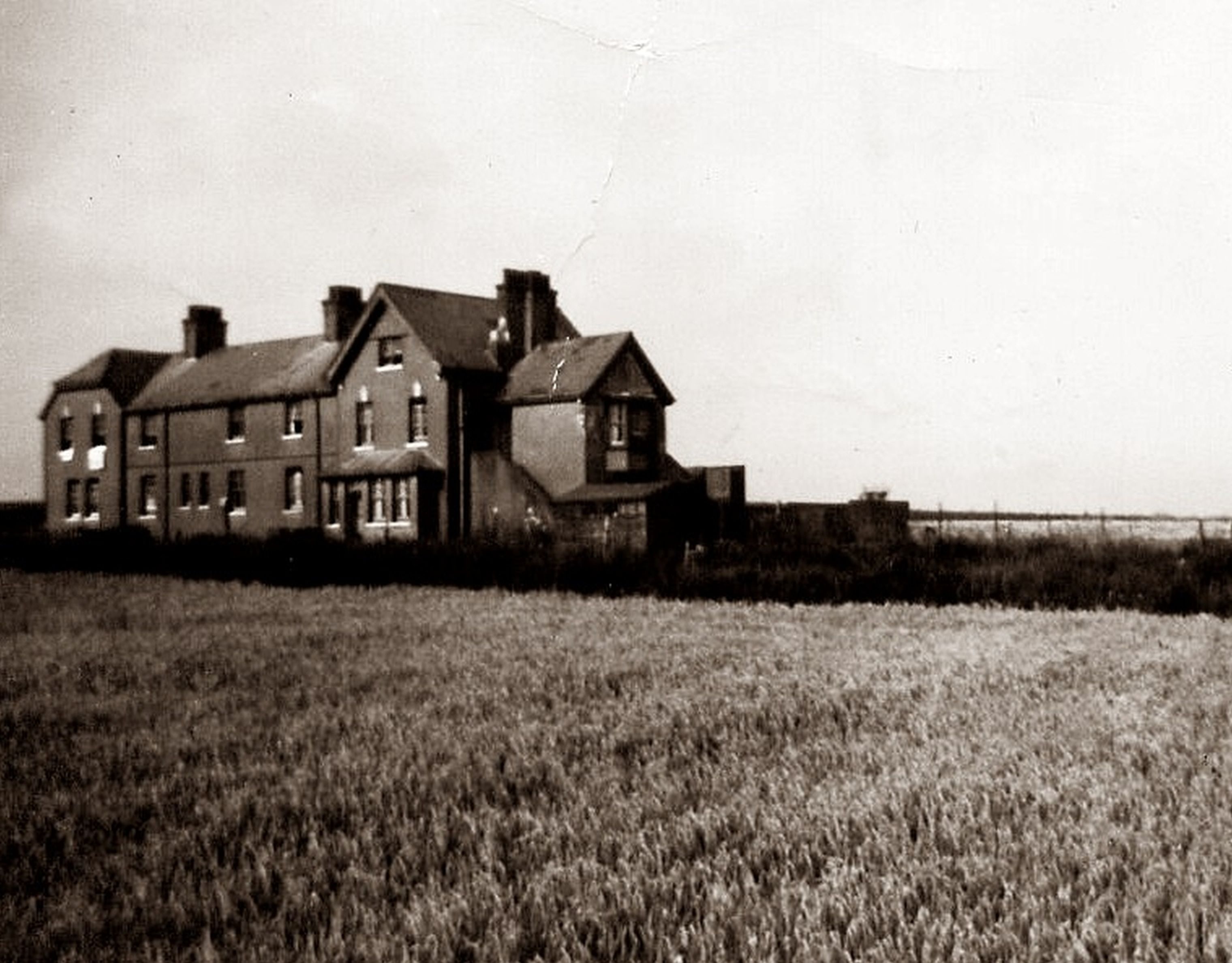 Grayscale Photo of House on Grass Field · Free Stock Photo