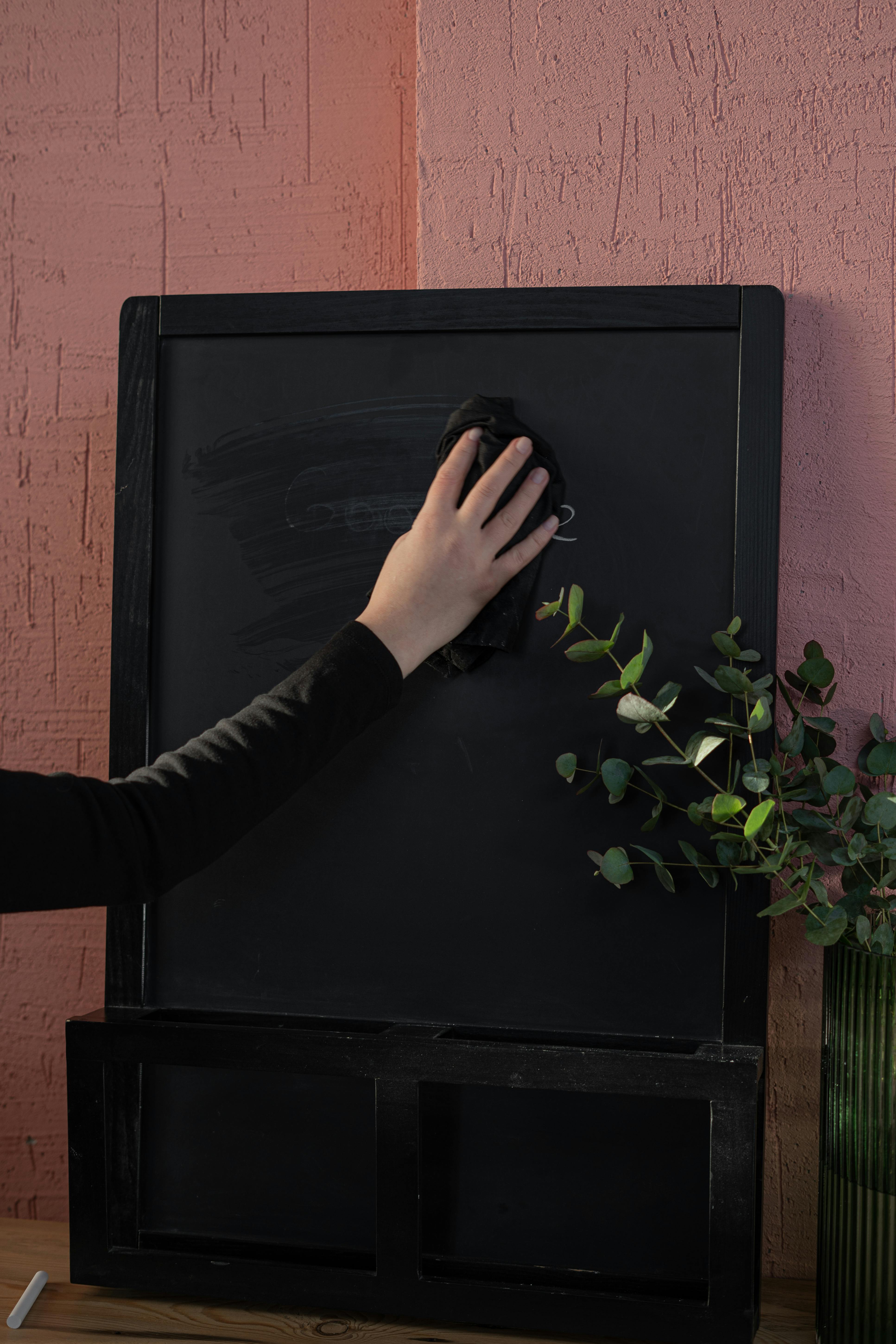 Person Erasing the Chalkboard · Free Stock Photo
