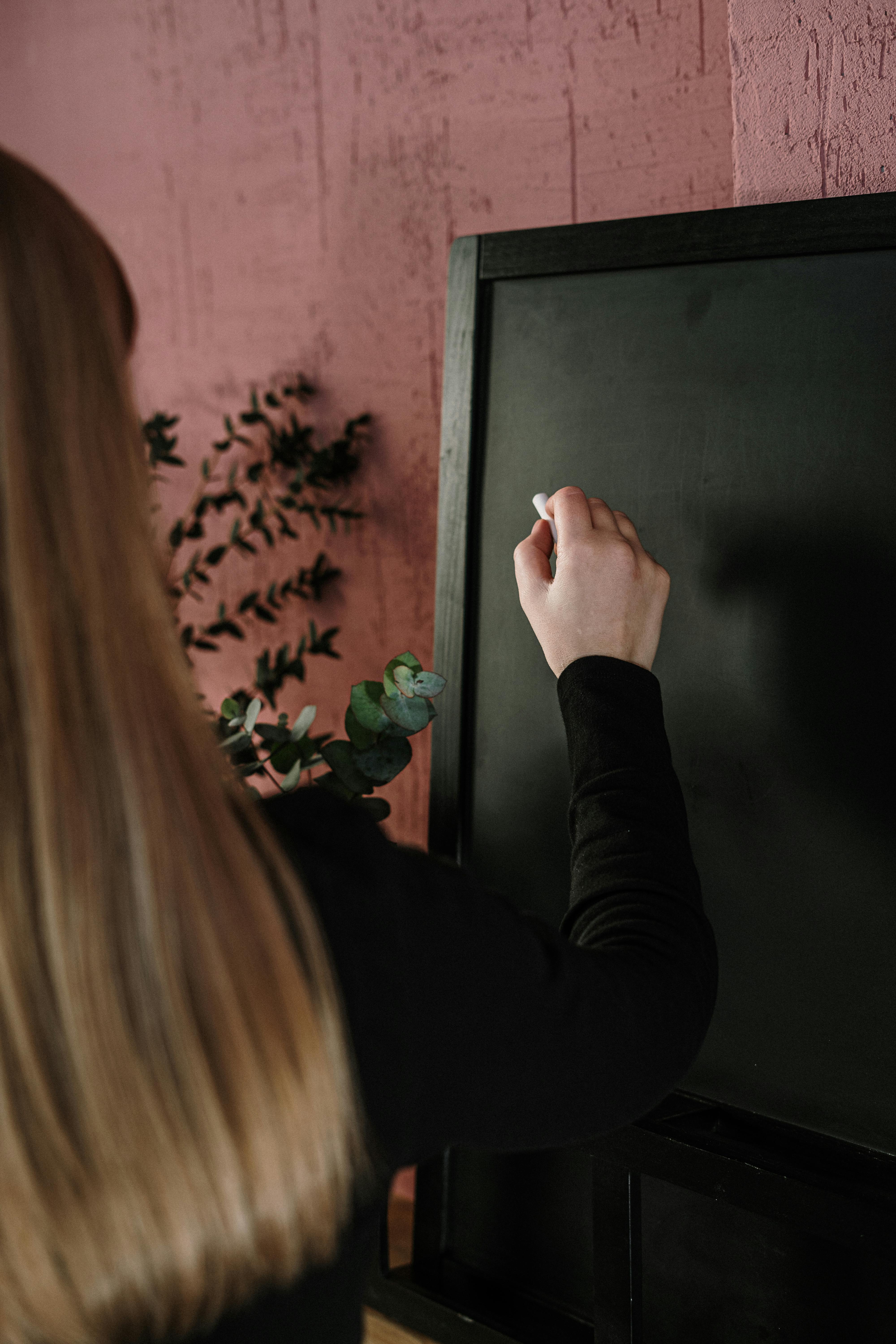 Person Erasing the Chalkboard · Free Stock Photo