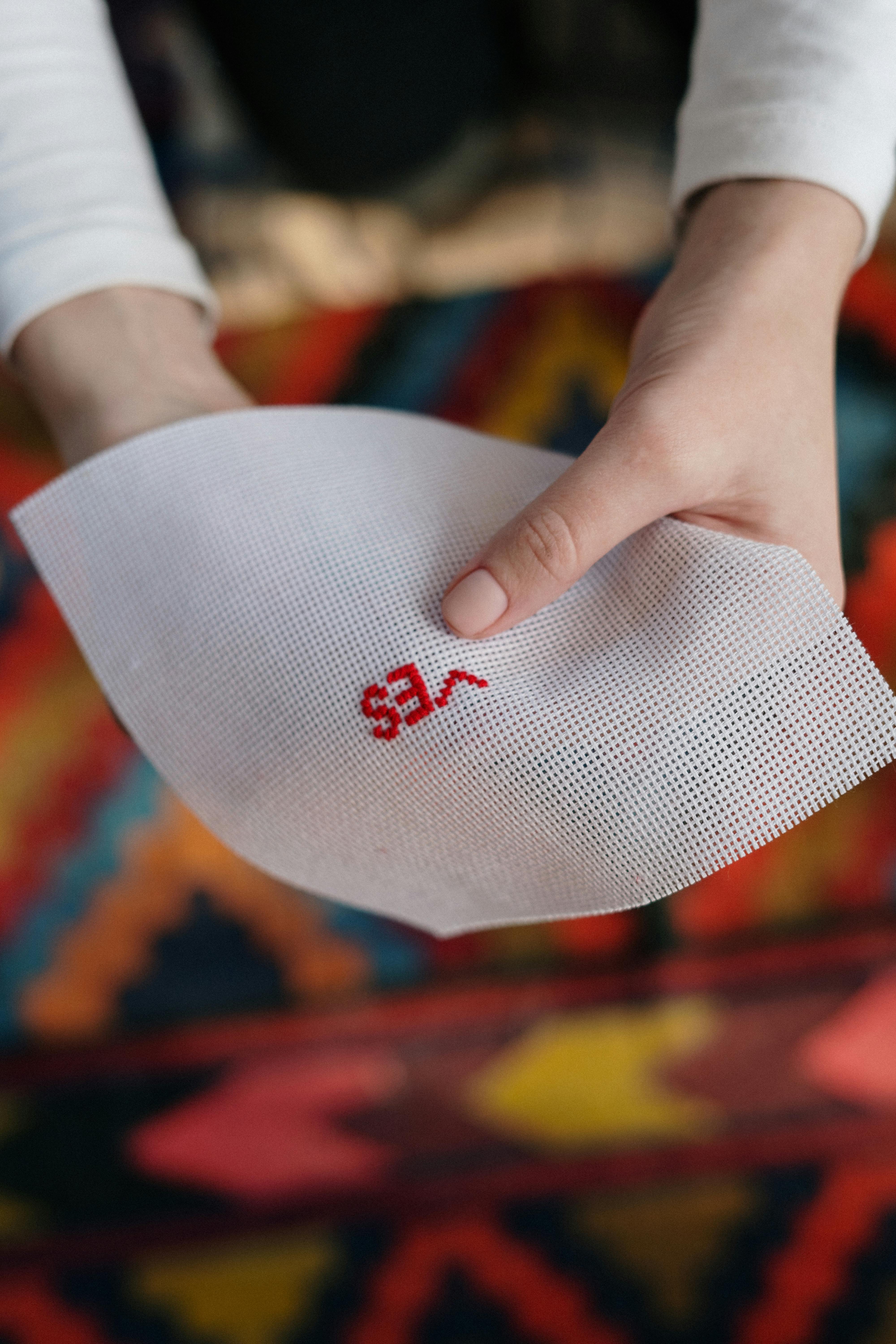 Person Hand Embroidering on White Textile · Free Stock Photo