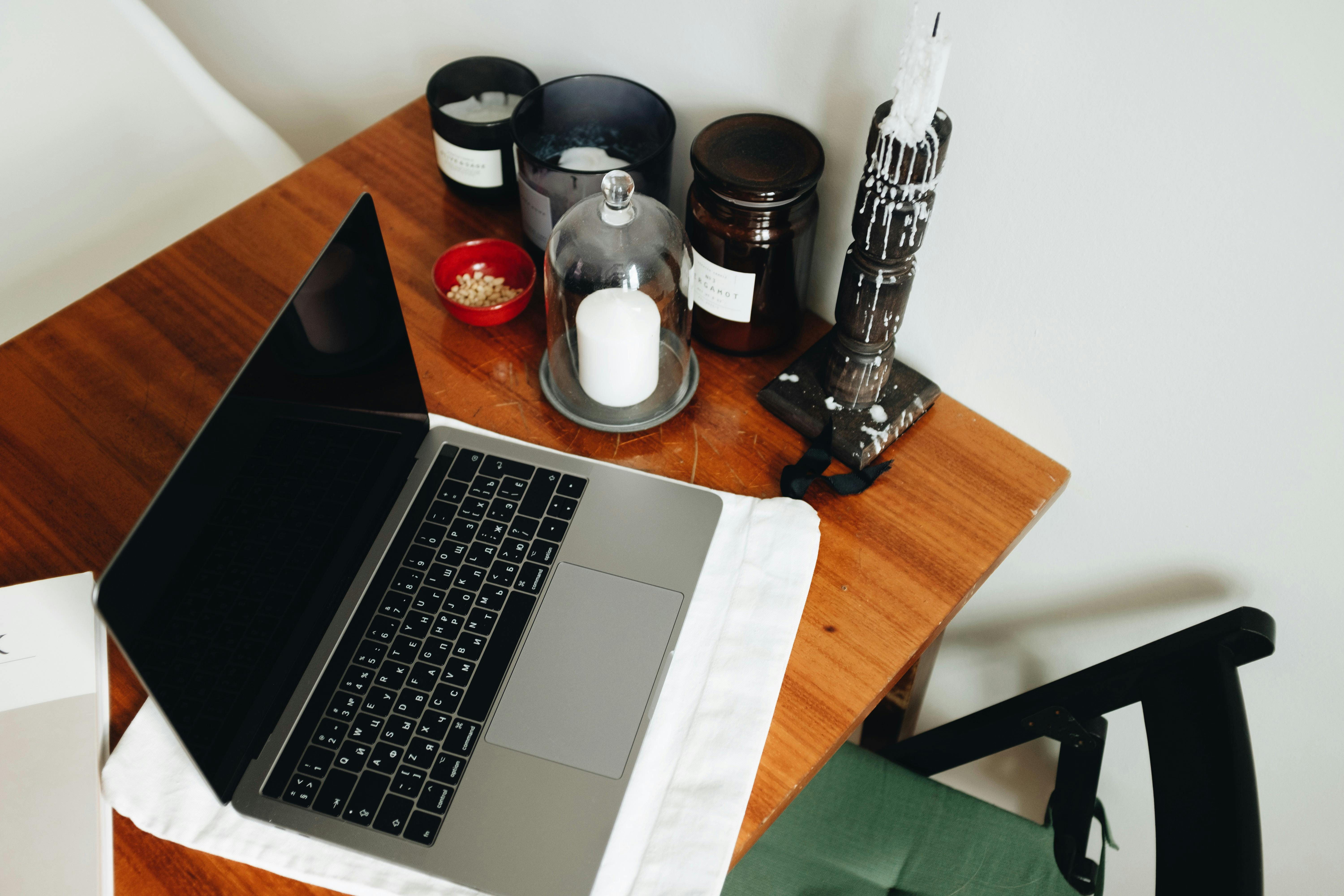 Macbook Pro On Brown Wooden Table · Free Stock Photo