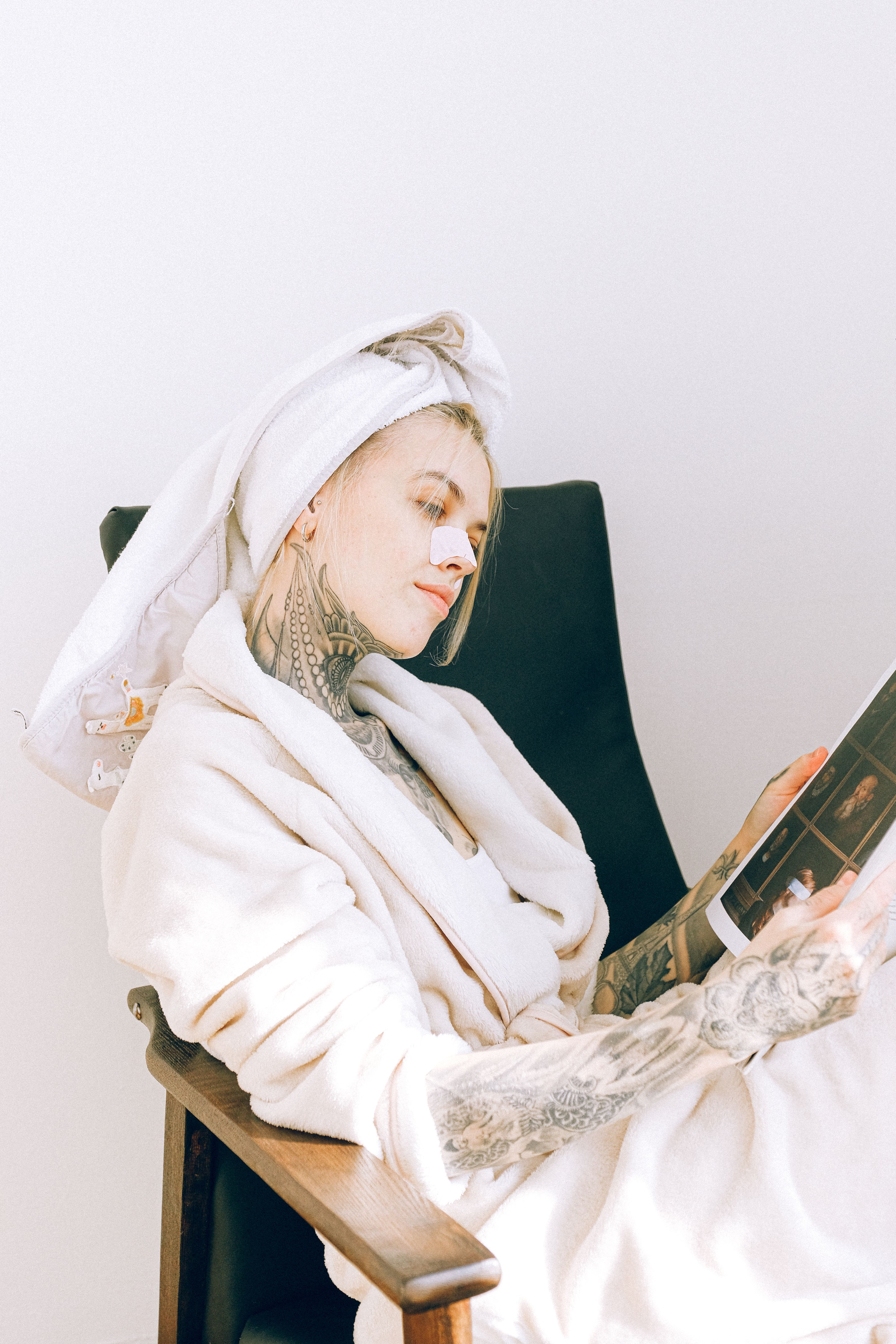 Young woman in nose mask on face reading magazine · Free Stock Photo