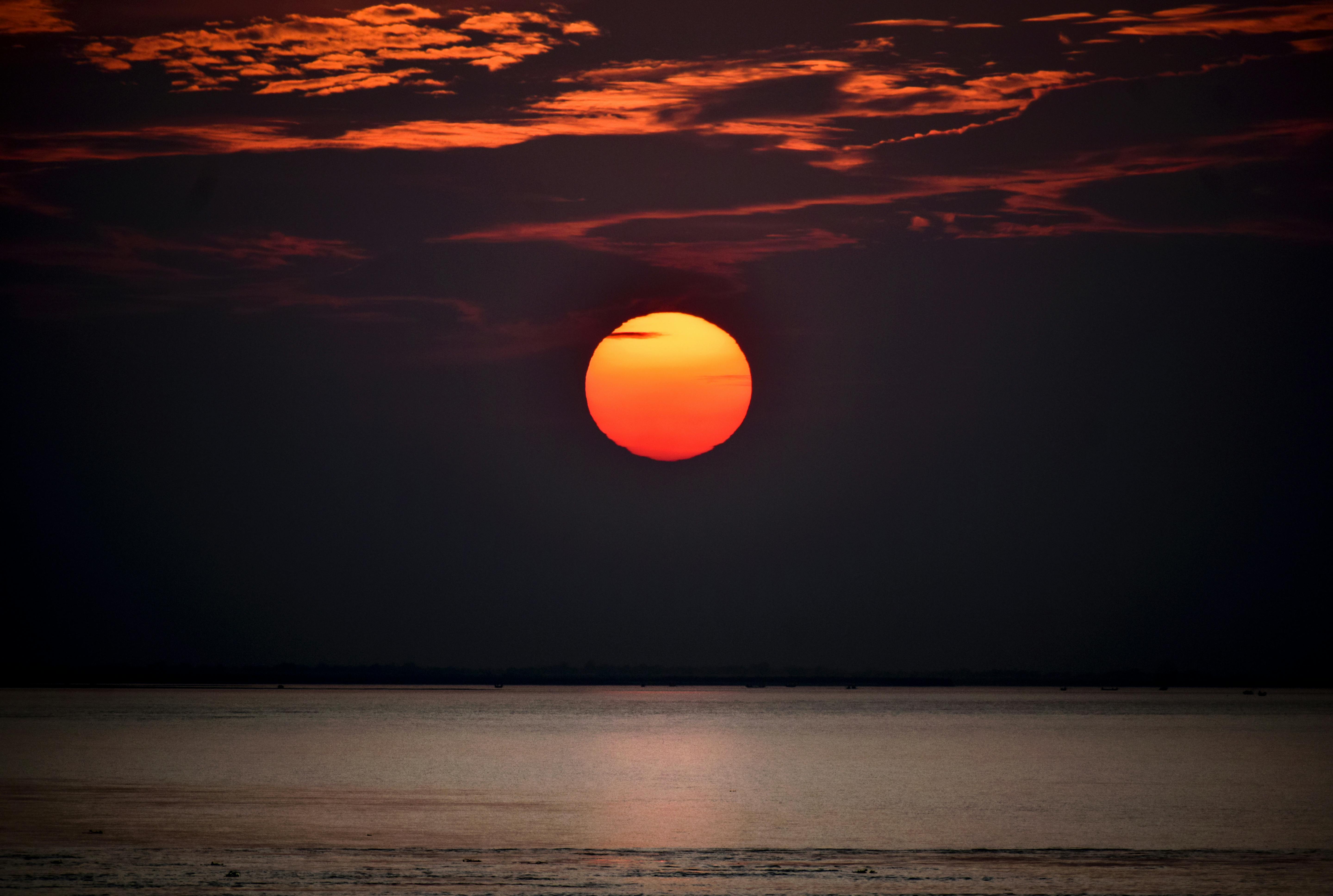 Sunset Over A Body Of Water · Free Stock Photo