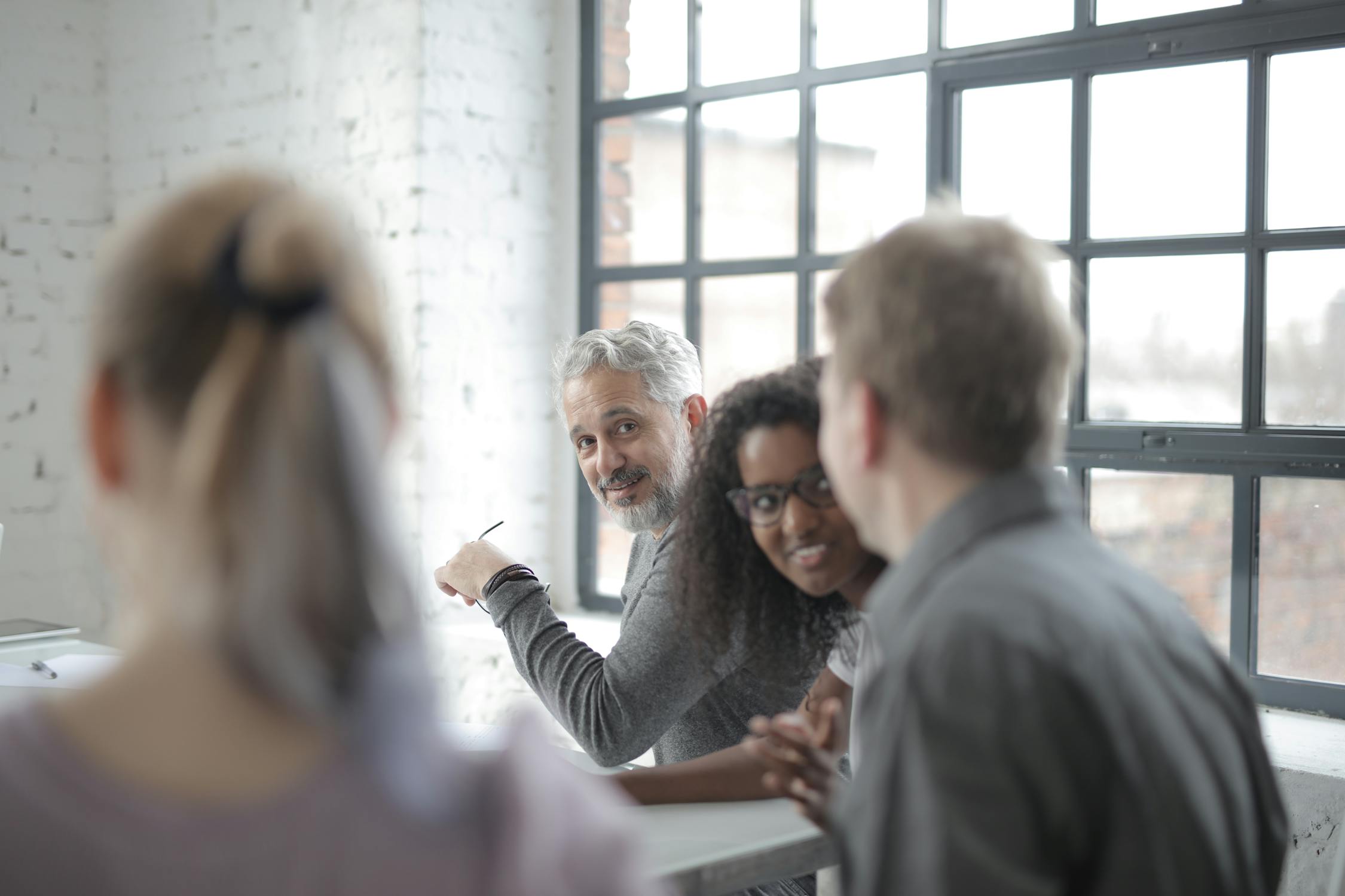 Multiracial colleagues of different ages having informal conversation ... Multiracial colleagues of different ages having informal conversation ...