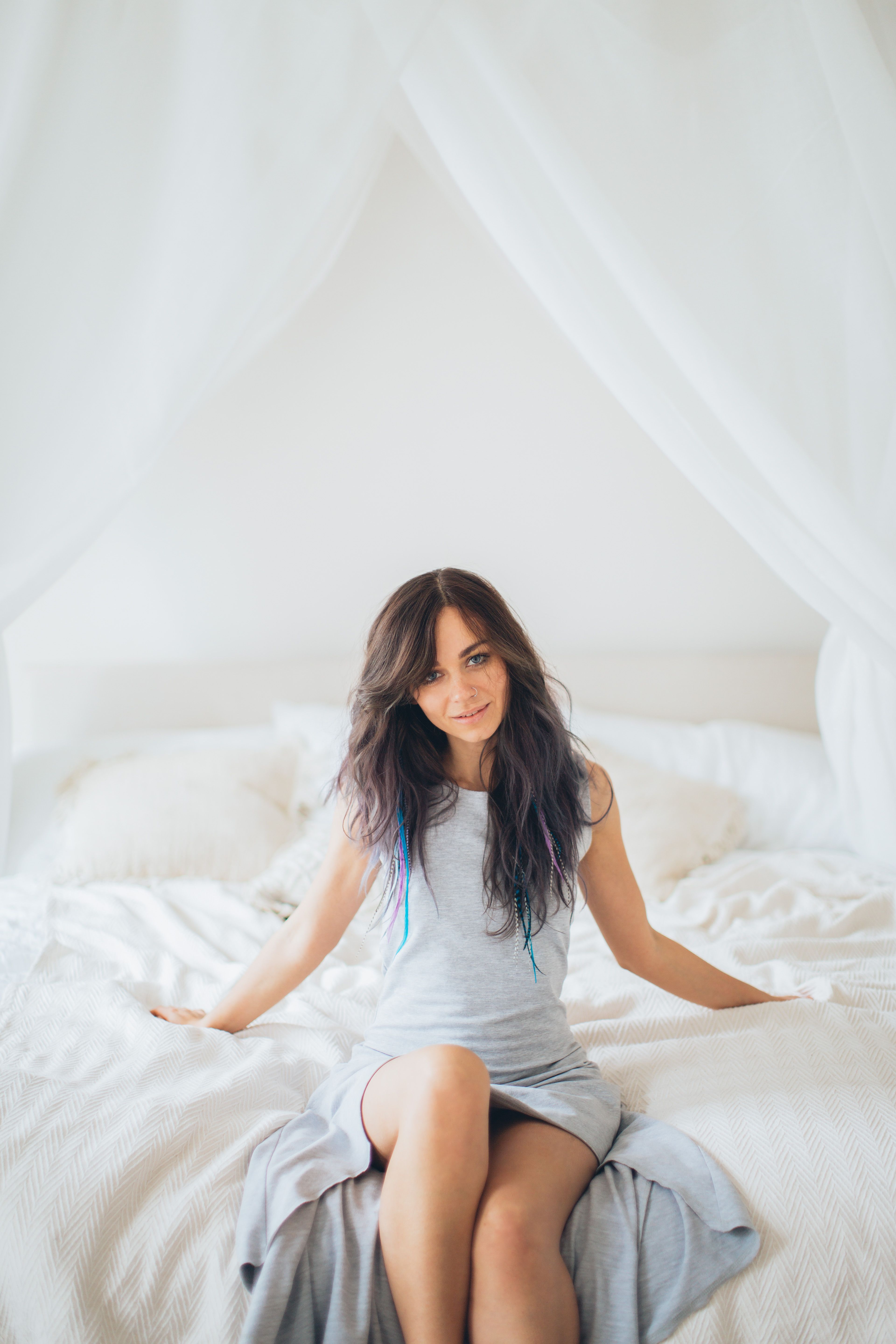 Portrait of a Woman Sitting on a Bed · Free Stock Photo