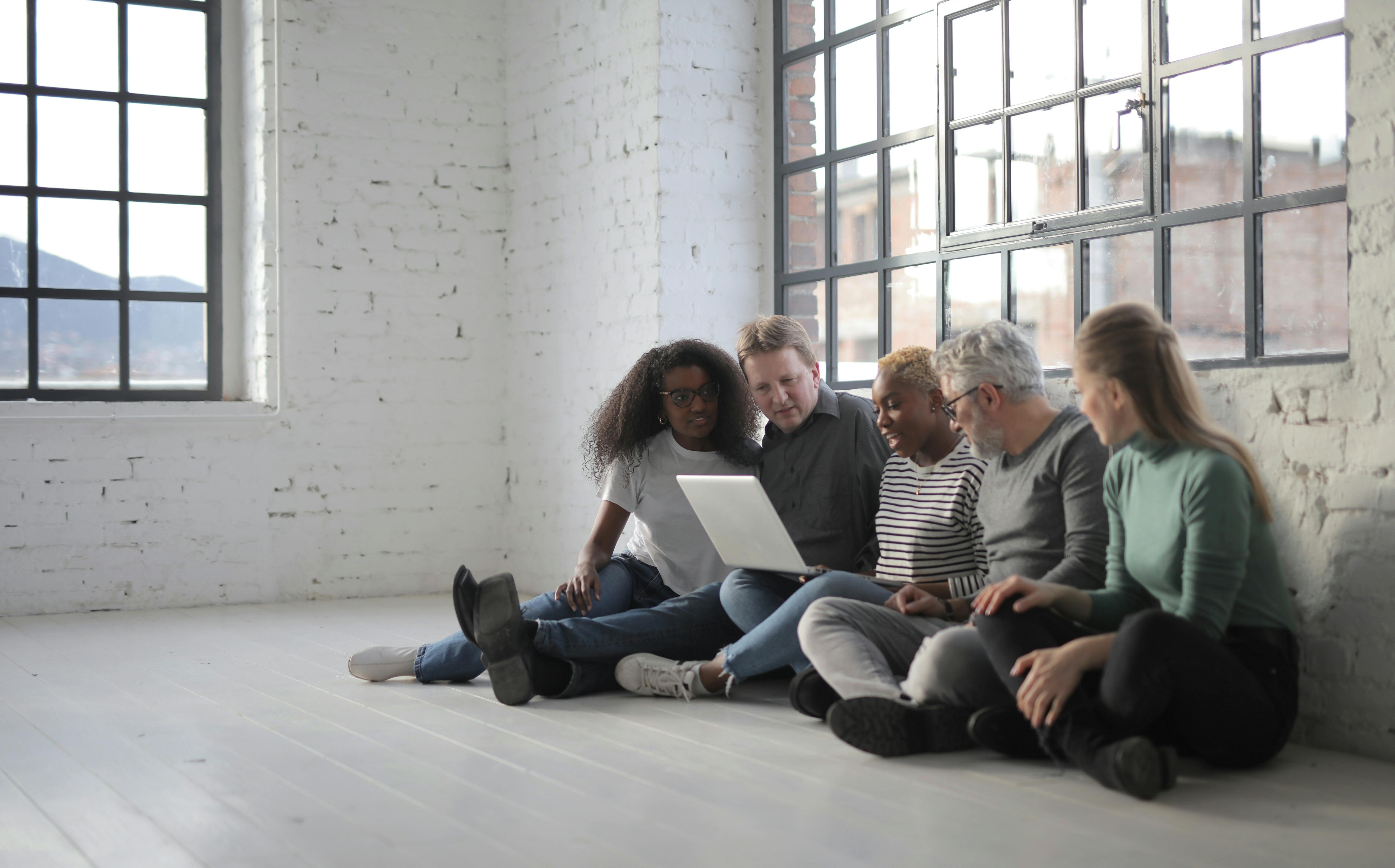 People Sitting on Floor While Using Laptop · Free Stock Photo