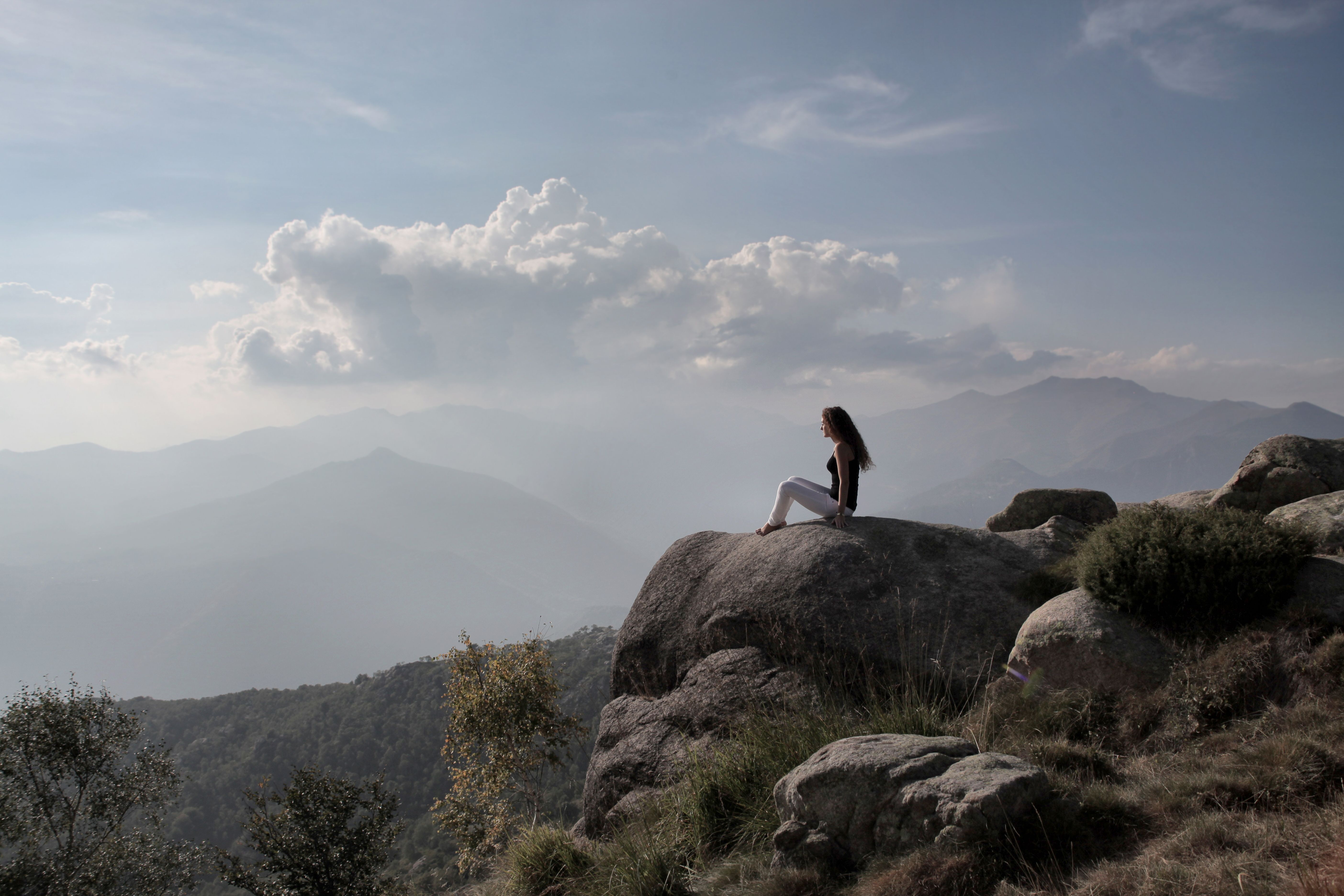 Woman Sitting on Rock Formation · Free Stock Photo