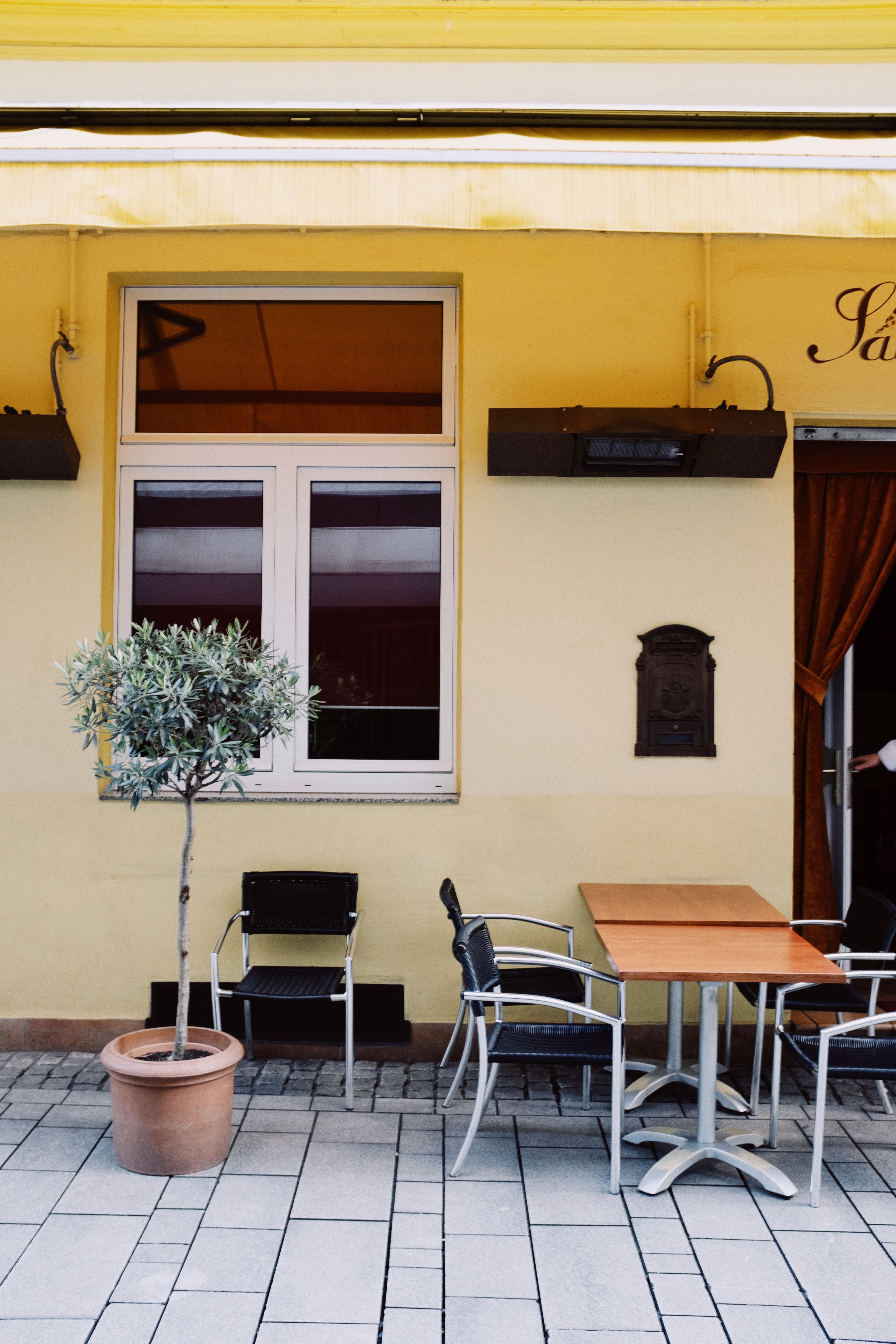 Terrace of modern street cafe with table and chairs in town · Free ...