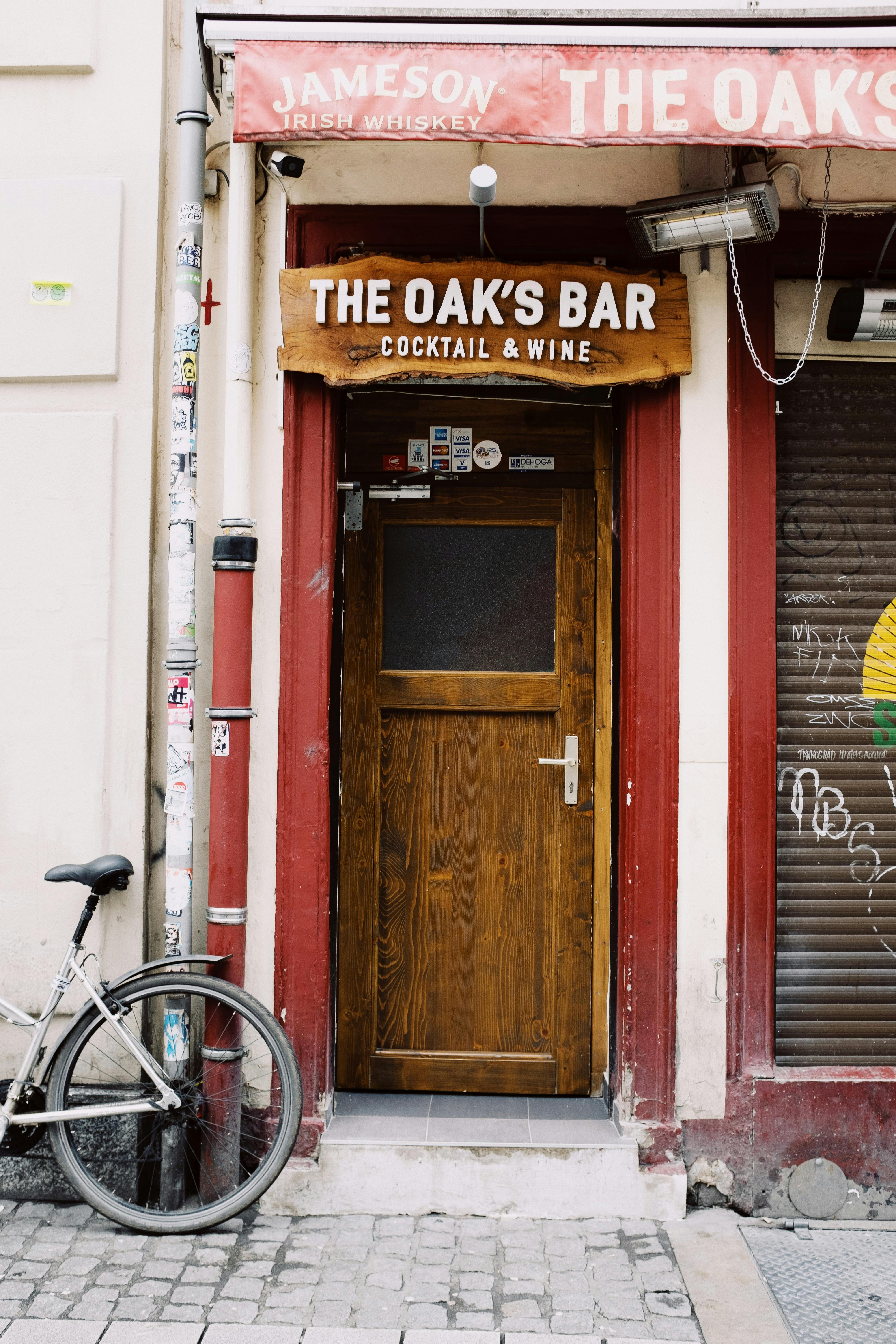 Door of closed bar with signboard and bicycle parked near entrance ...