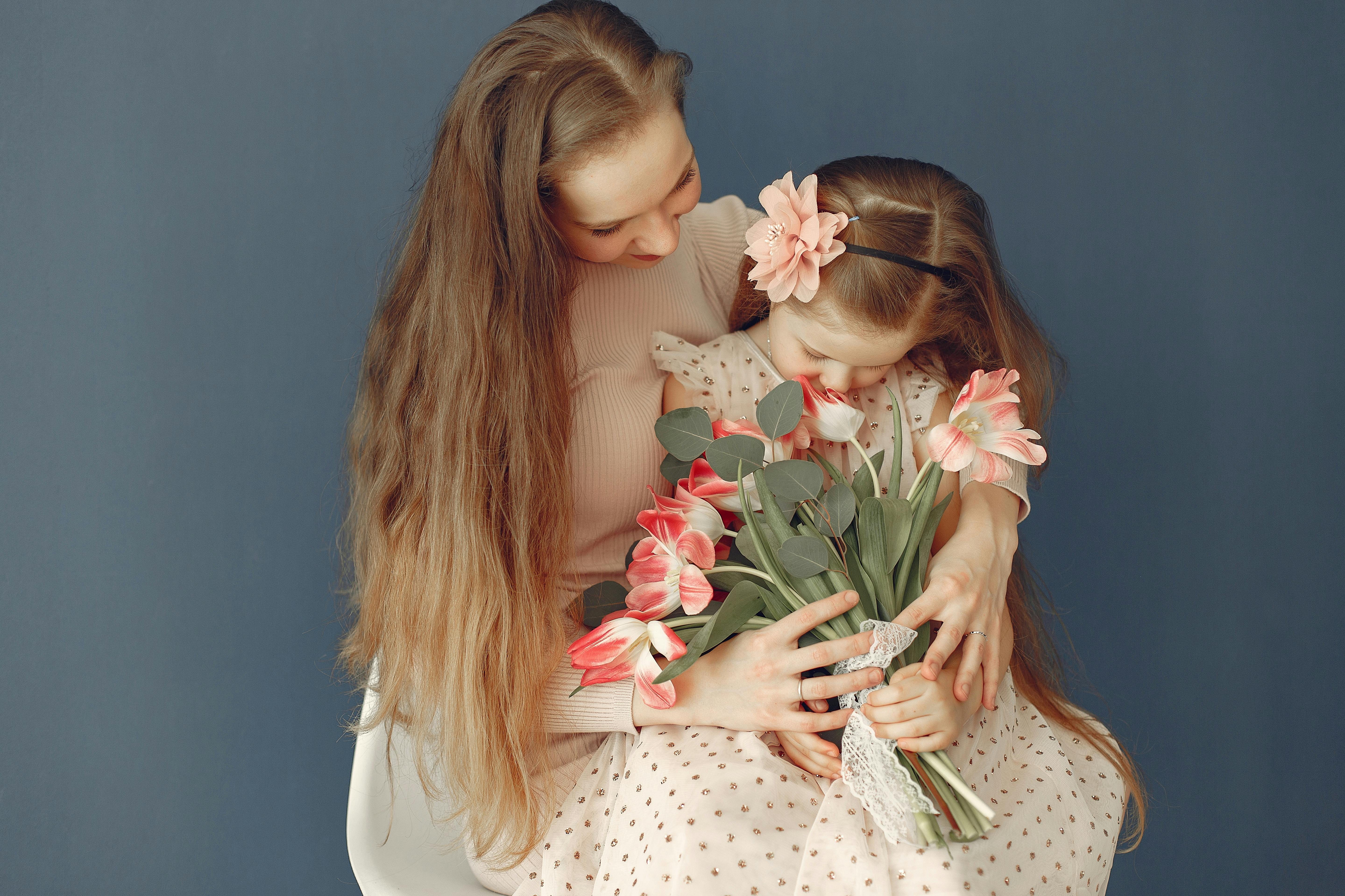 Mother And Child With A Bouquet of Flowers · Free Stock Photo