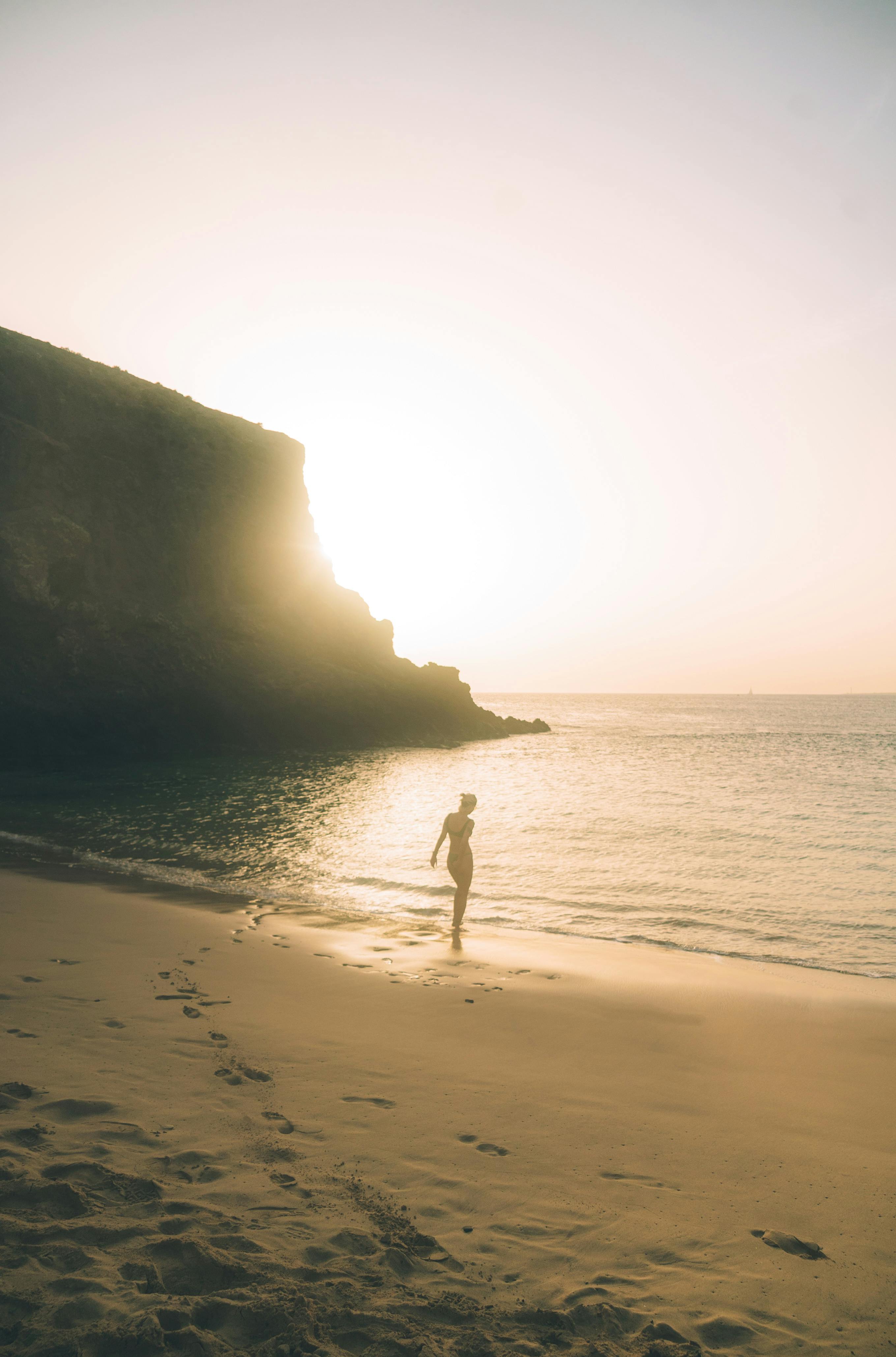 Person Walking On Beach · Free Stock Photo