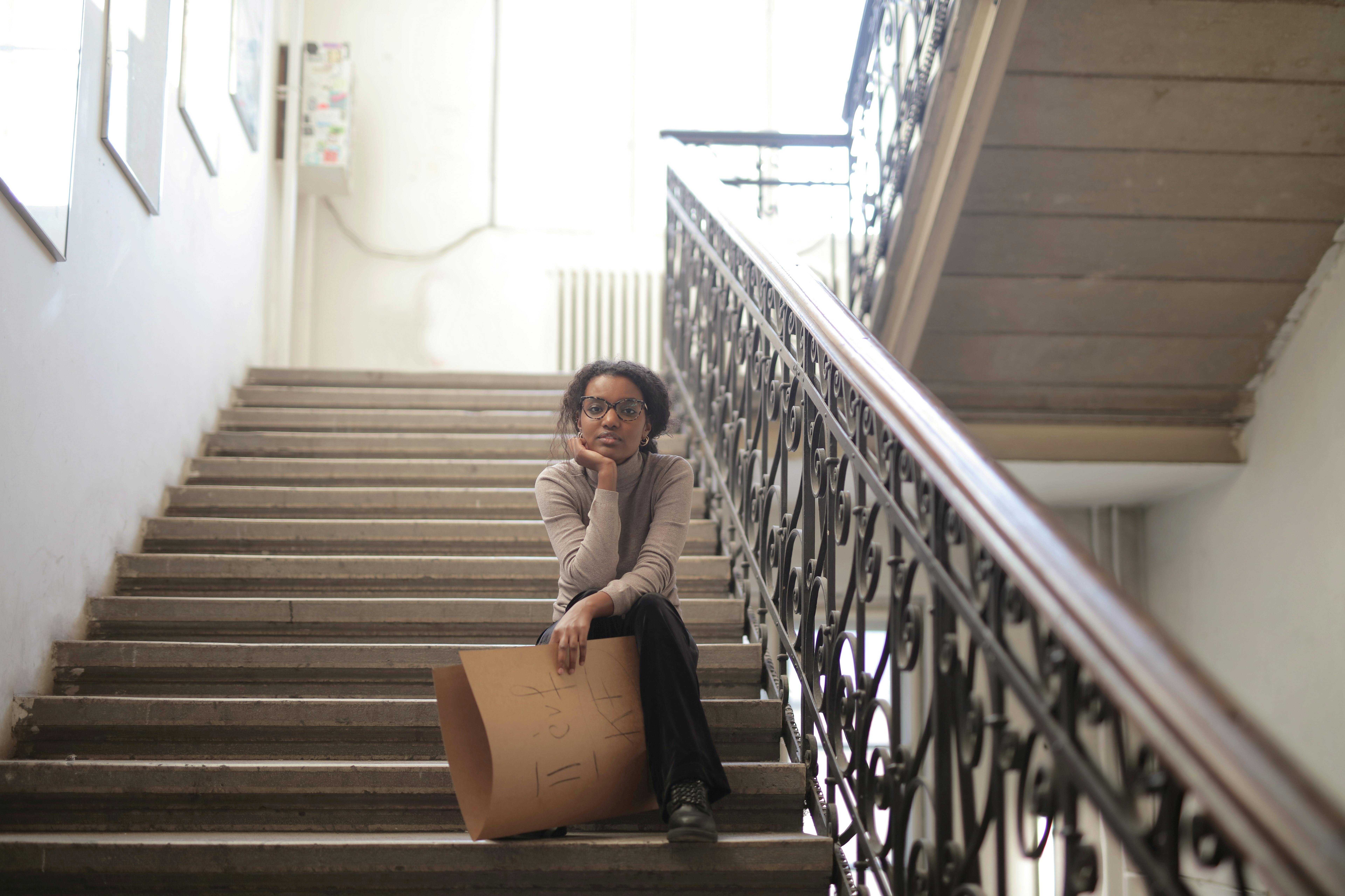 Woman Sitting on Staircase · Free Stock Photo