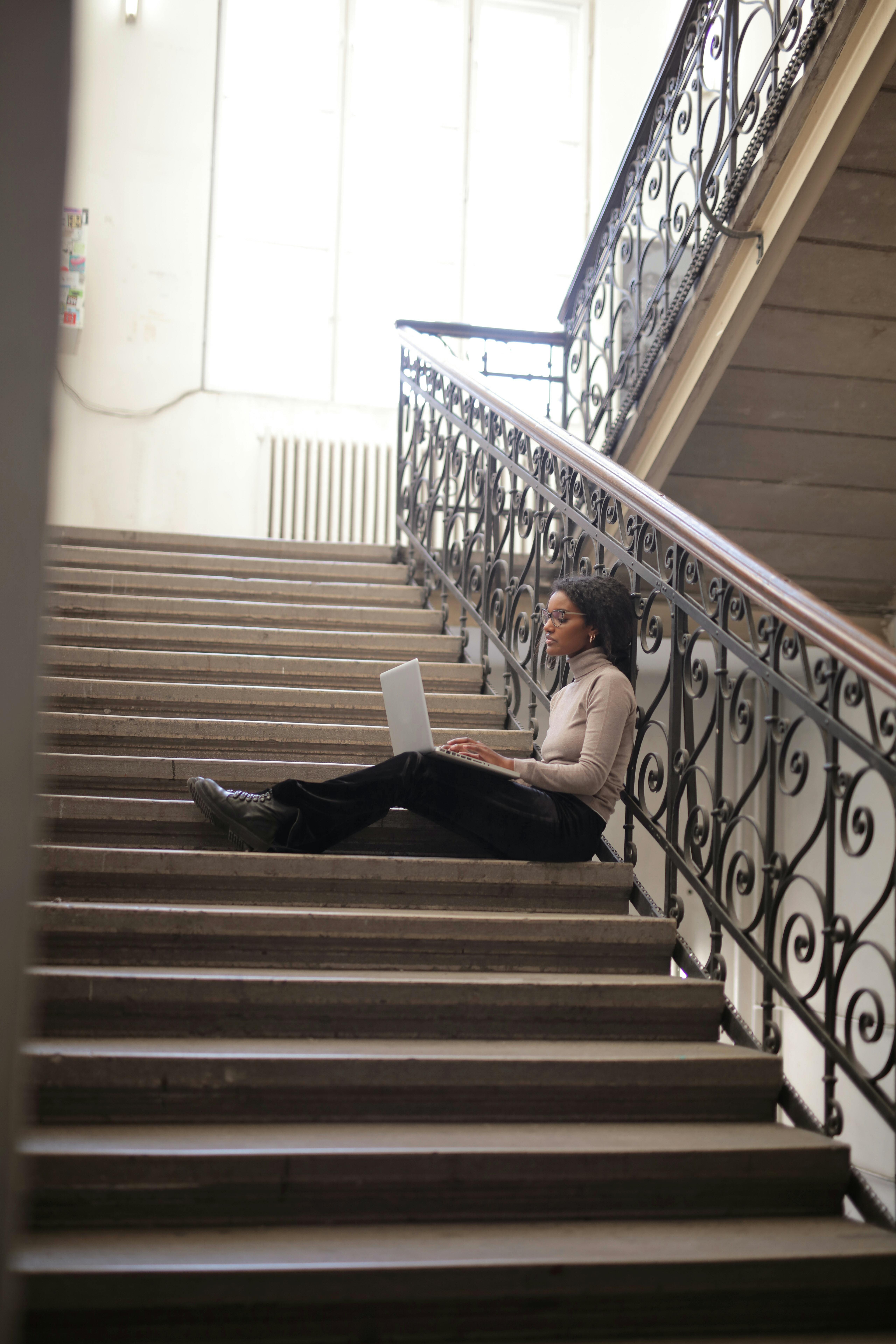 Woman Sitting On Staircase · Free Stock Photo