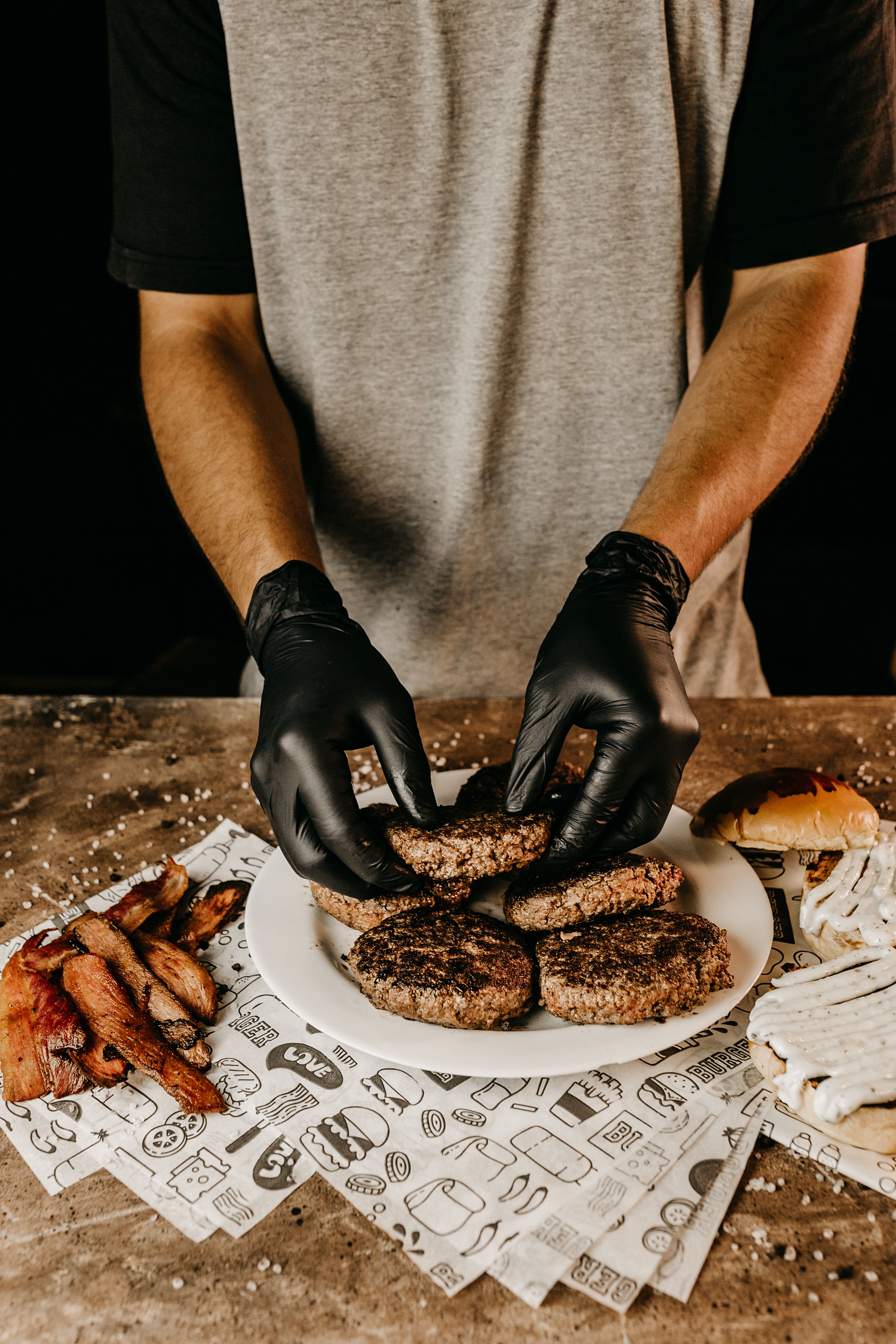 Person In Gray T-shirt Holding A Patty · Free Stock Photo