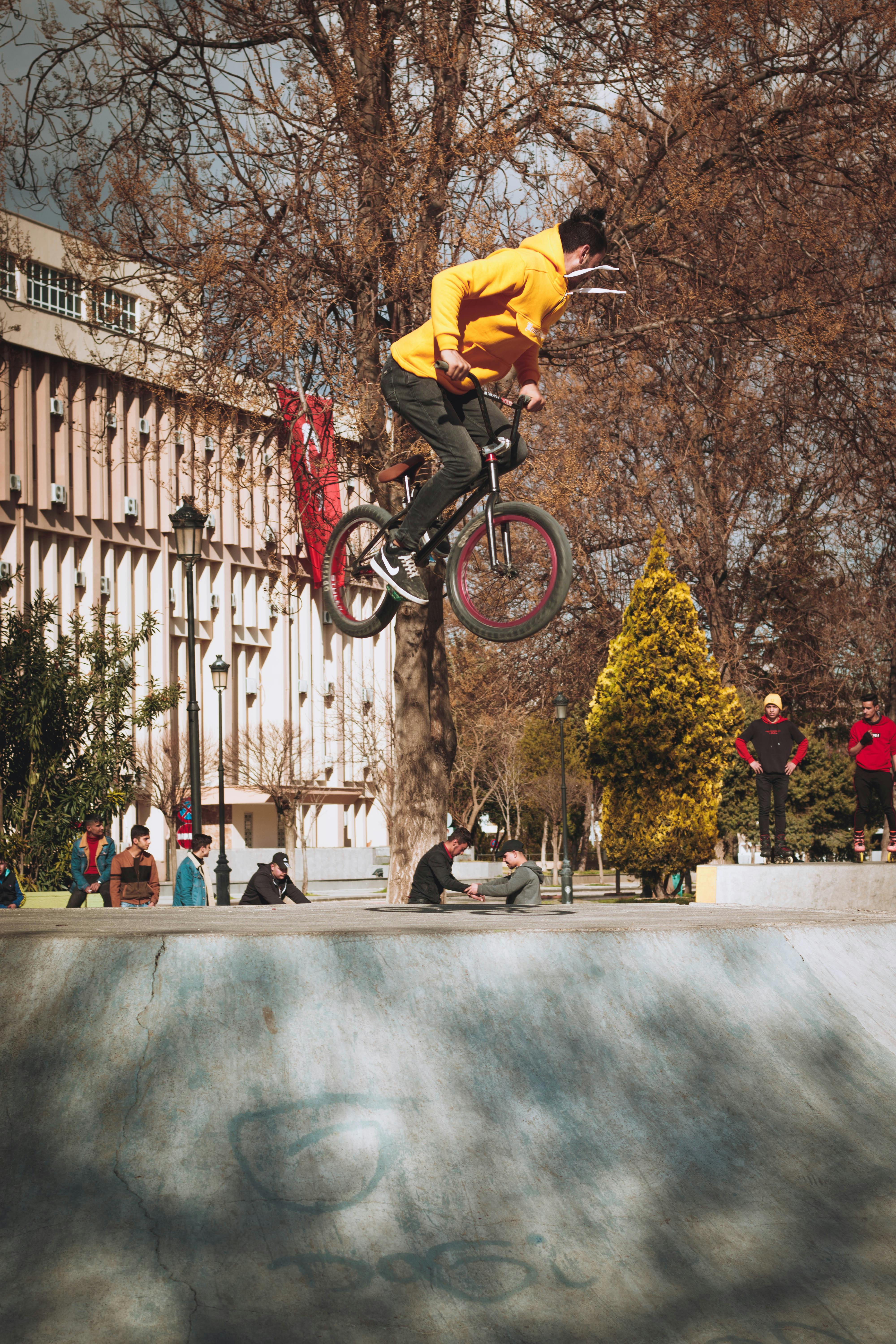 Man In Yellow Jacket Riding Bicycle · Free Stock Photo