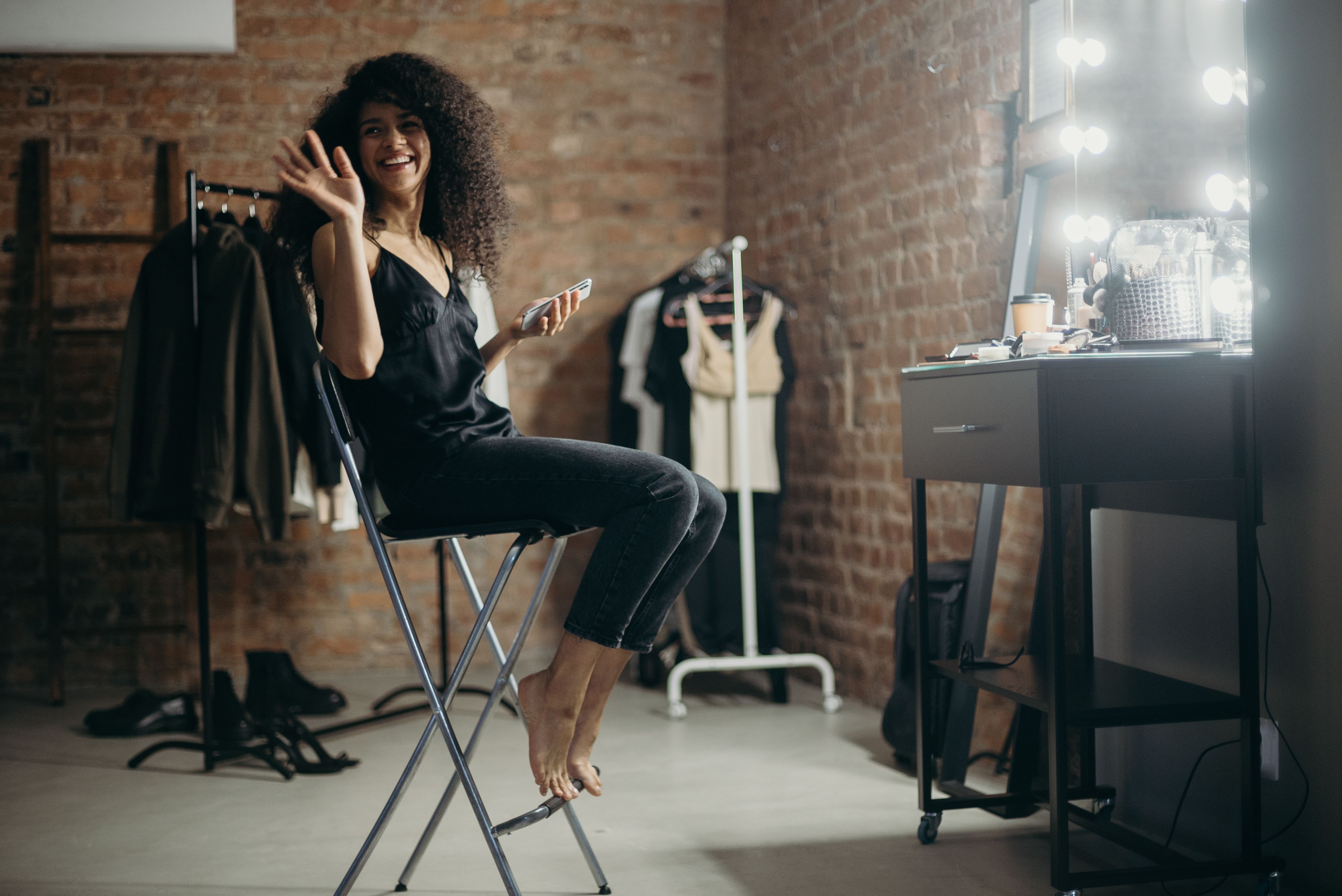 Woman In Black Top And Black Pants Sitting On Chair · Free Stock Photo