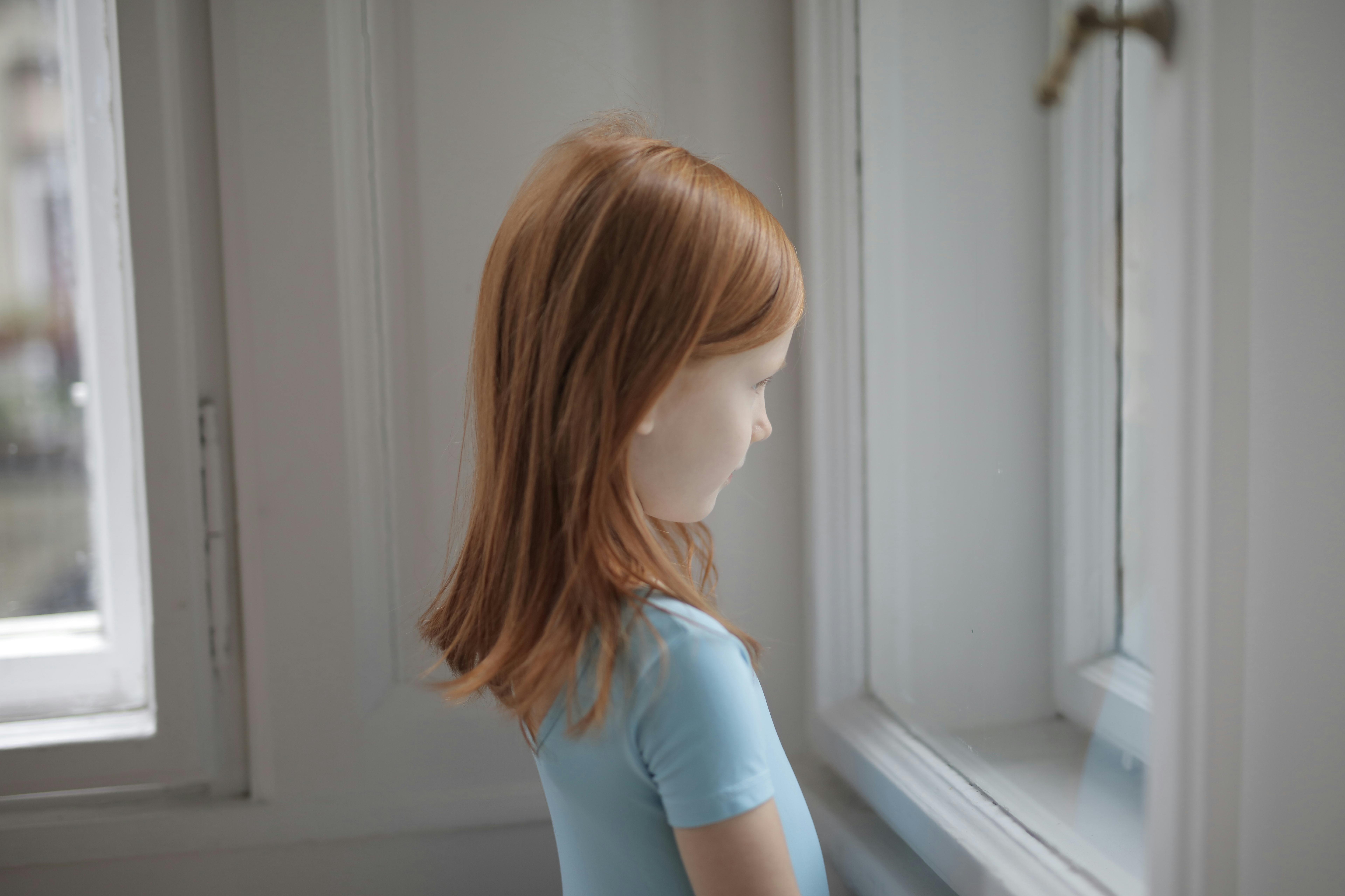 Girl in Blue T-shirt Looking Out the Window · Free Stock Photo